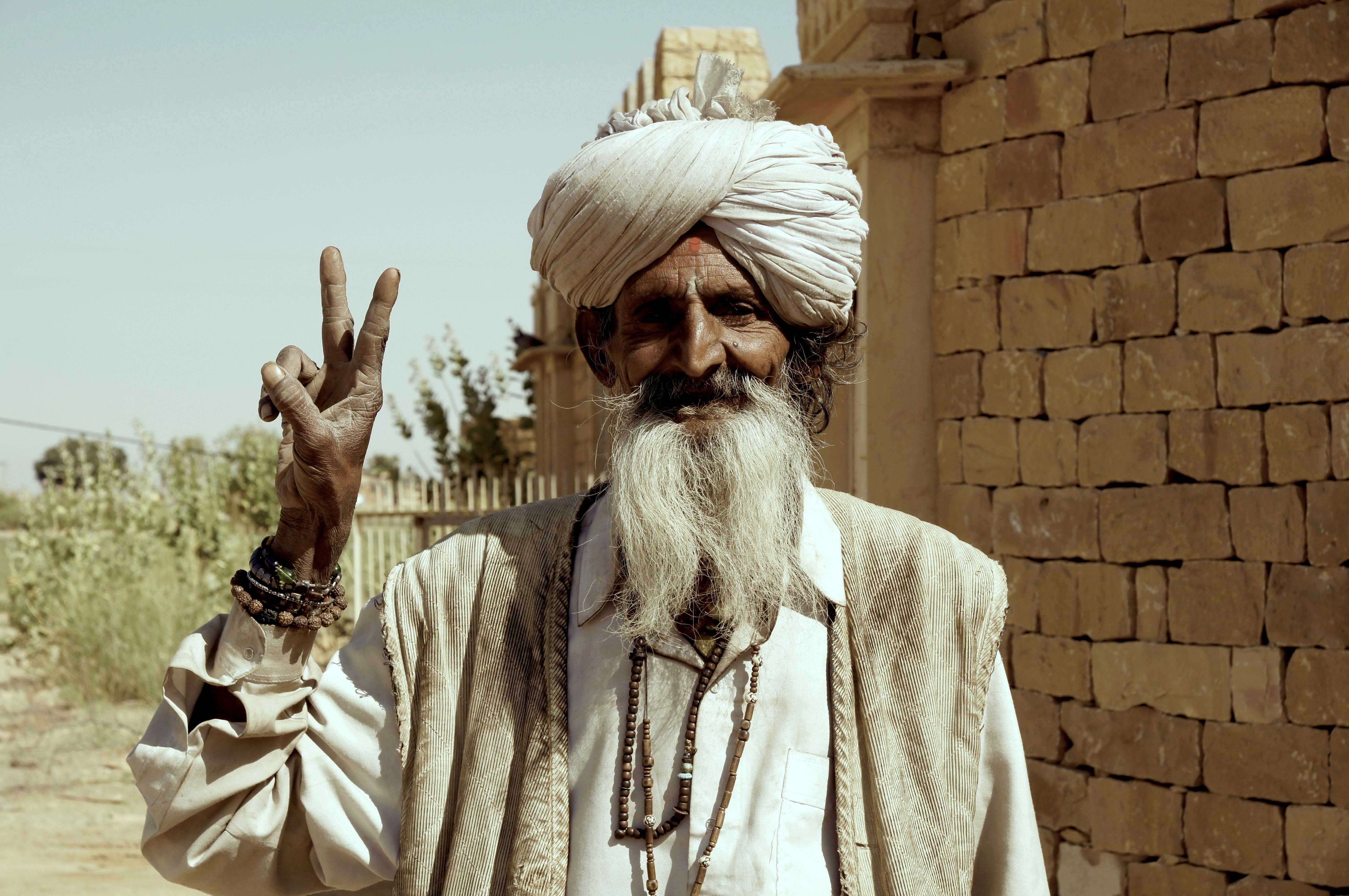 An Elderly Man Wearing Turban Doing Peace Sign · Free Stock Photo