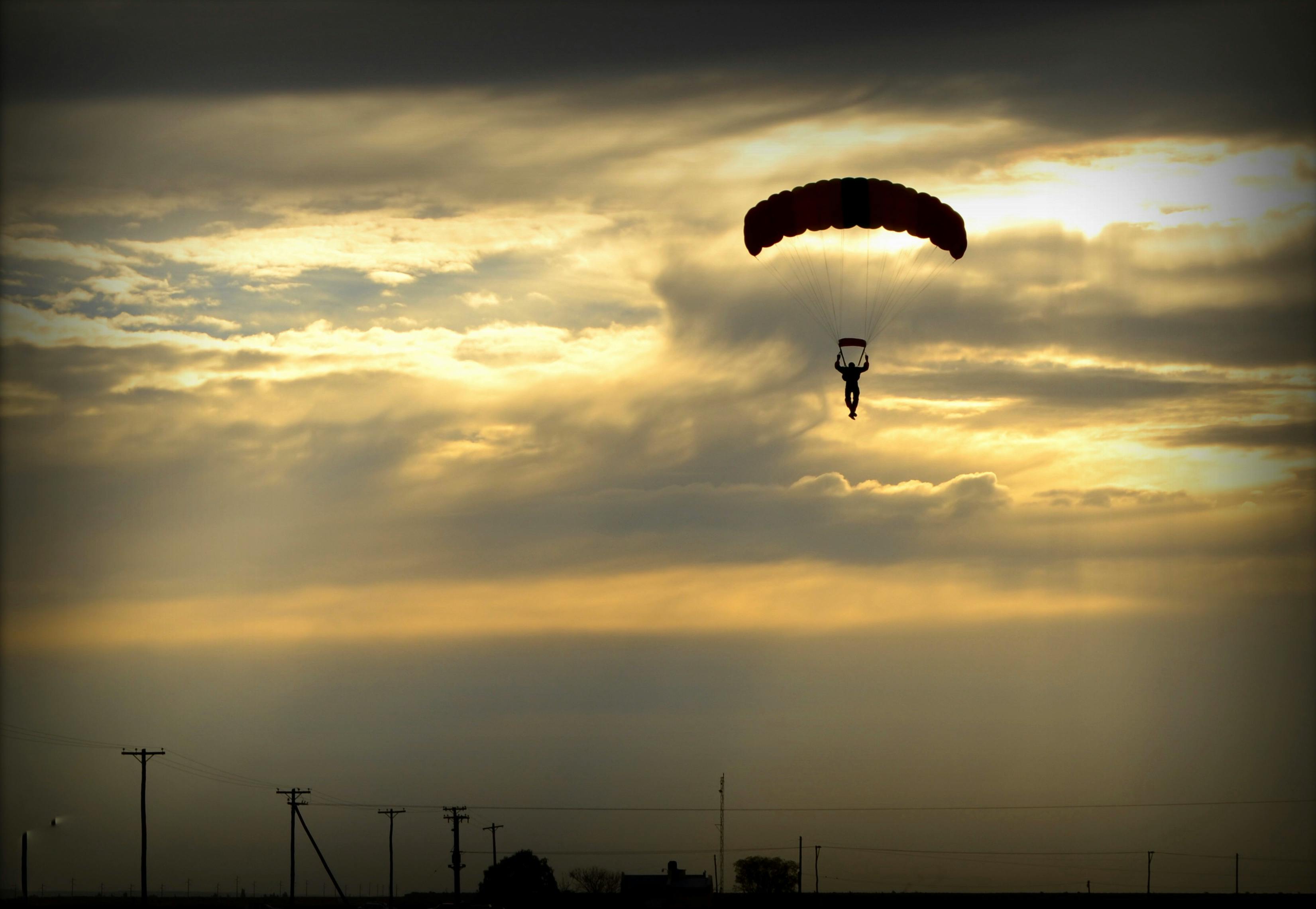 Person Parachuting under Clouds · Free Stock Photo