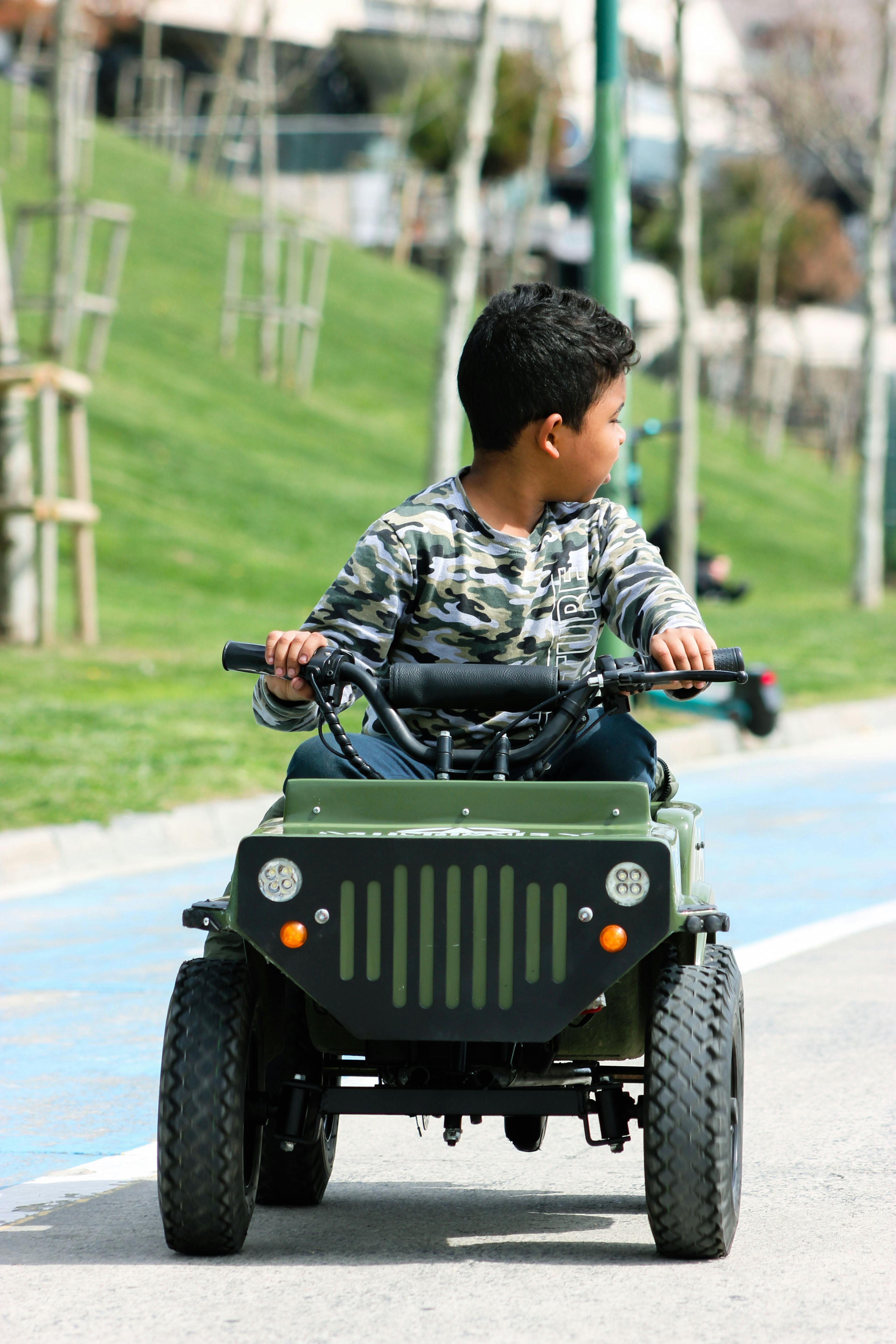A Young Boy Driving a Car · Free Stock Photo