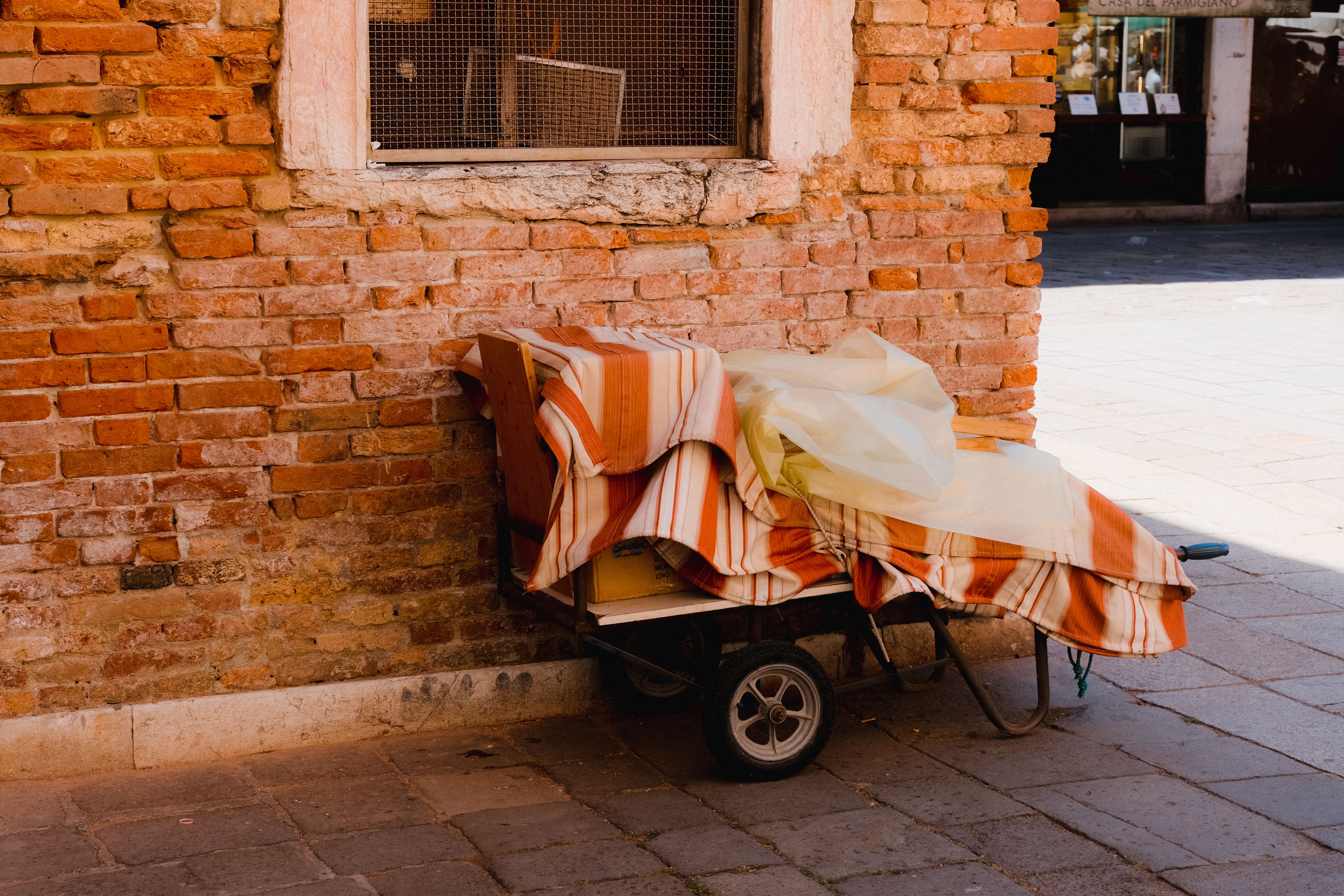 Cart Parked on the Sidewalk by the Building · Free Stock Photo