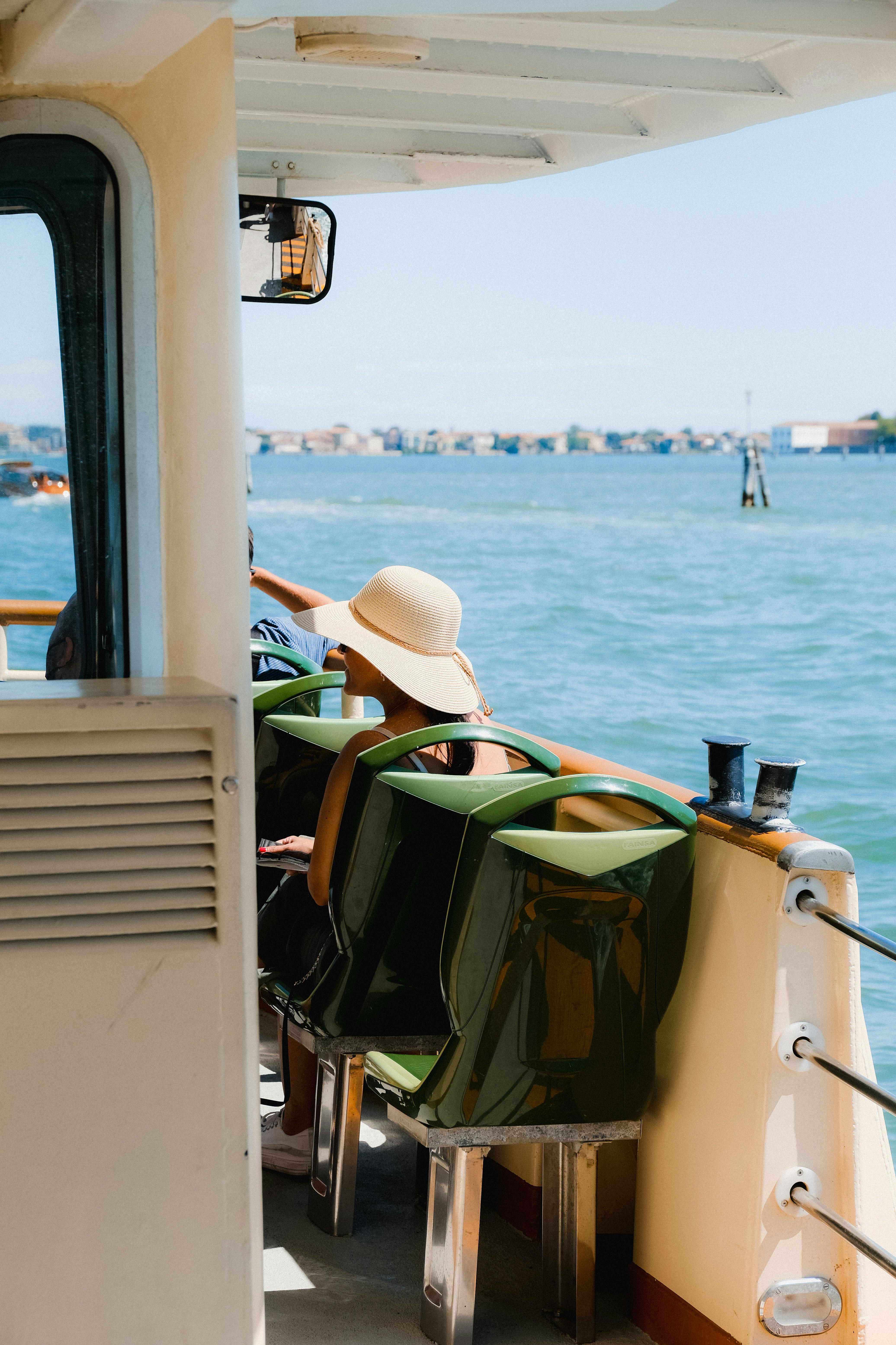 Back View of a Woman Sitting on a Boat · Free Stock Photo