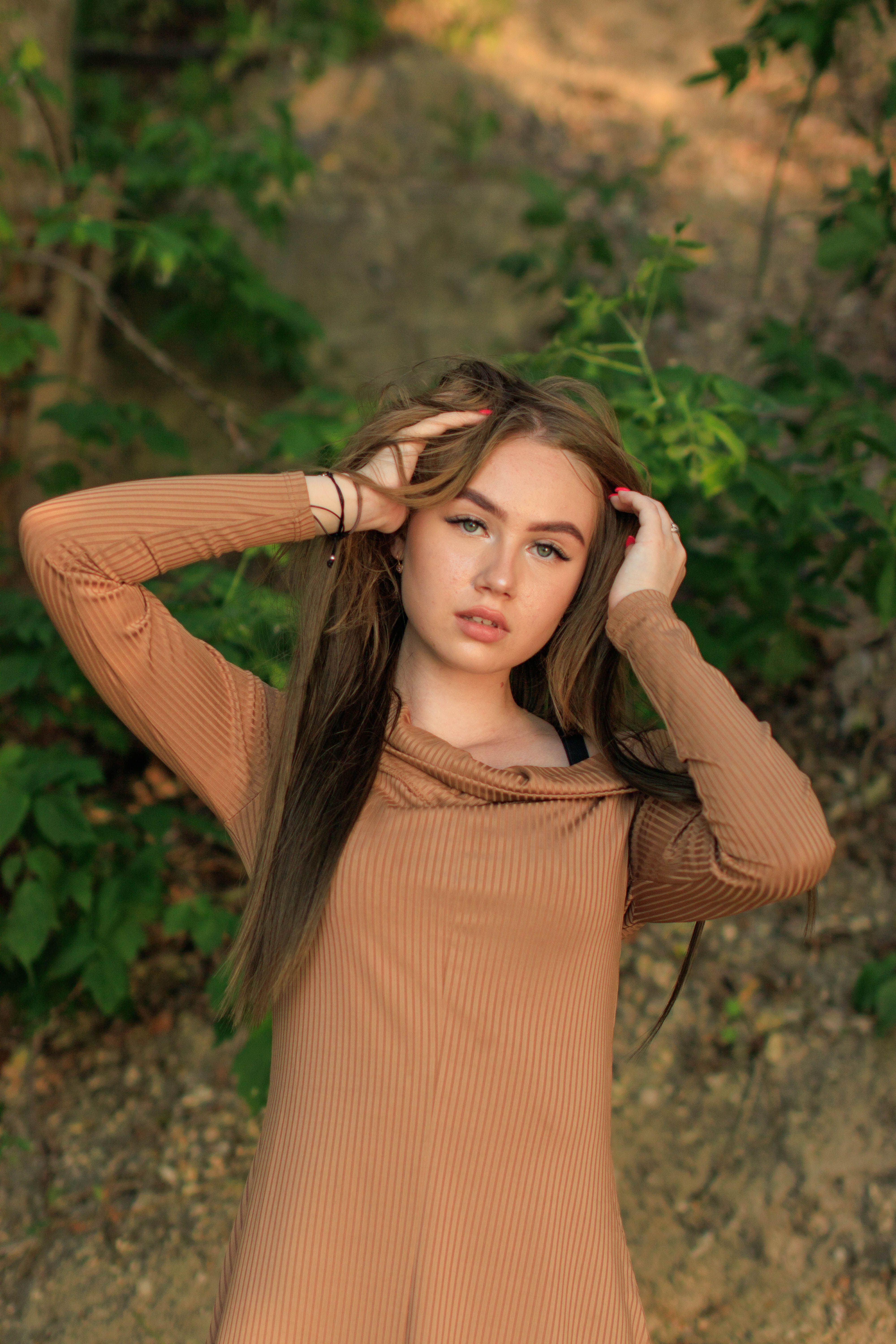 A Pretty Woman in Brown Long Sleeves · Free Stock Photo