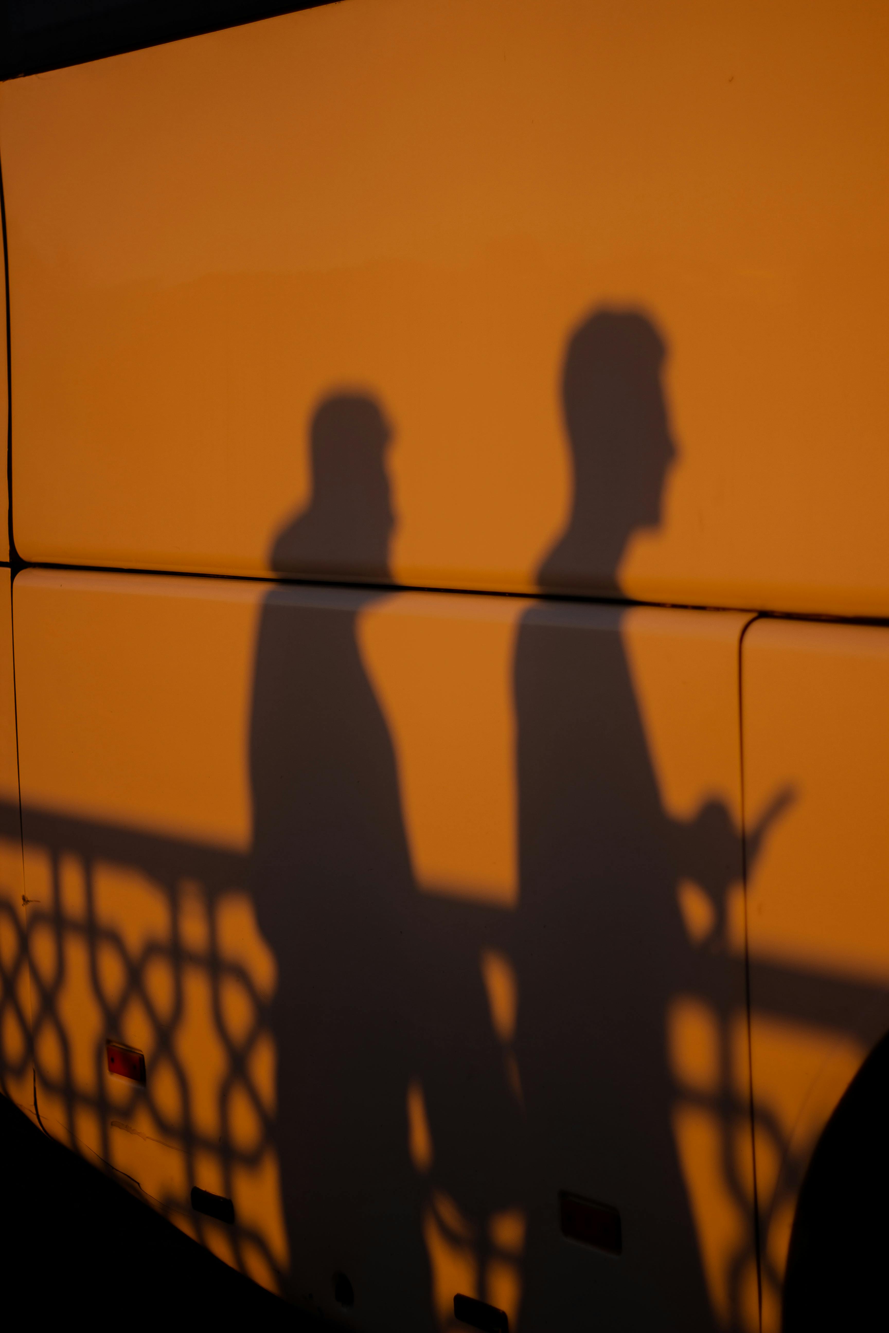 Shadow of Two People on a Wall · Free Stock Photo