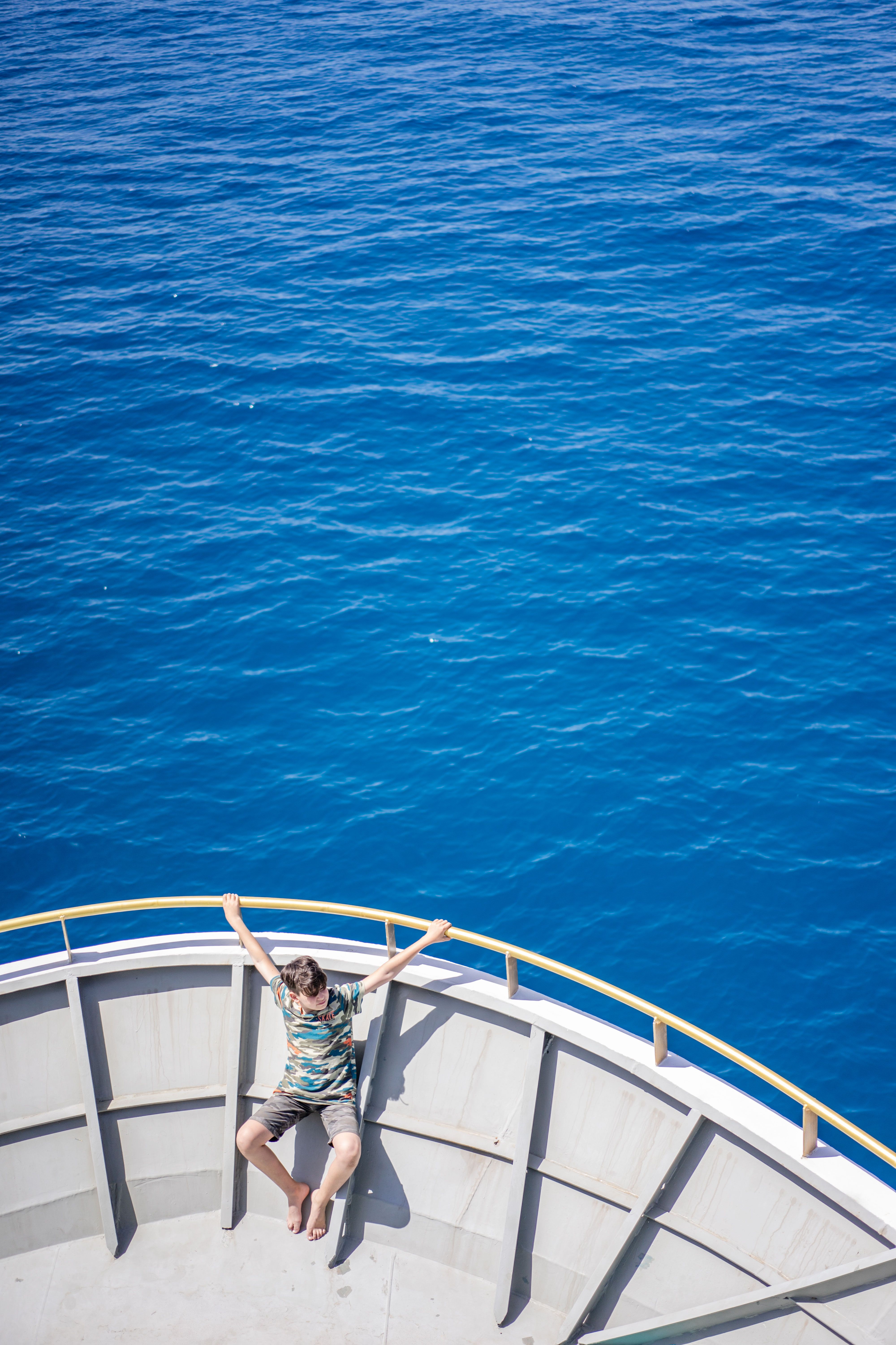 Man Sitting on Ship Deck · Free Stock Photo