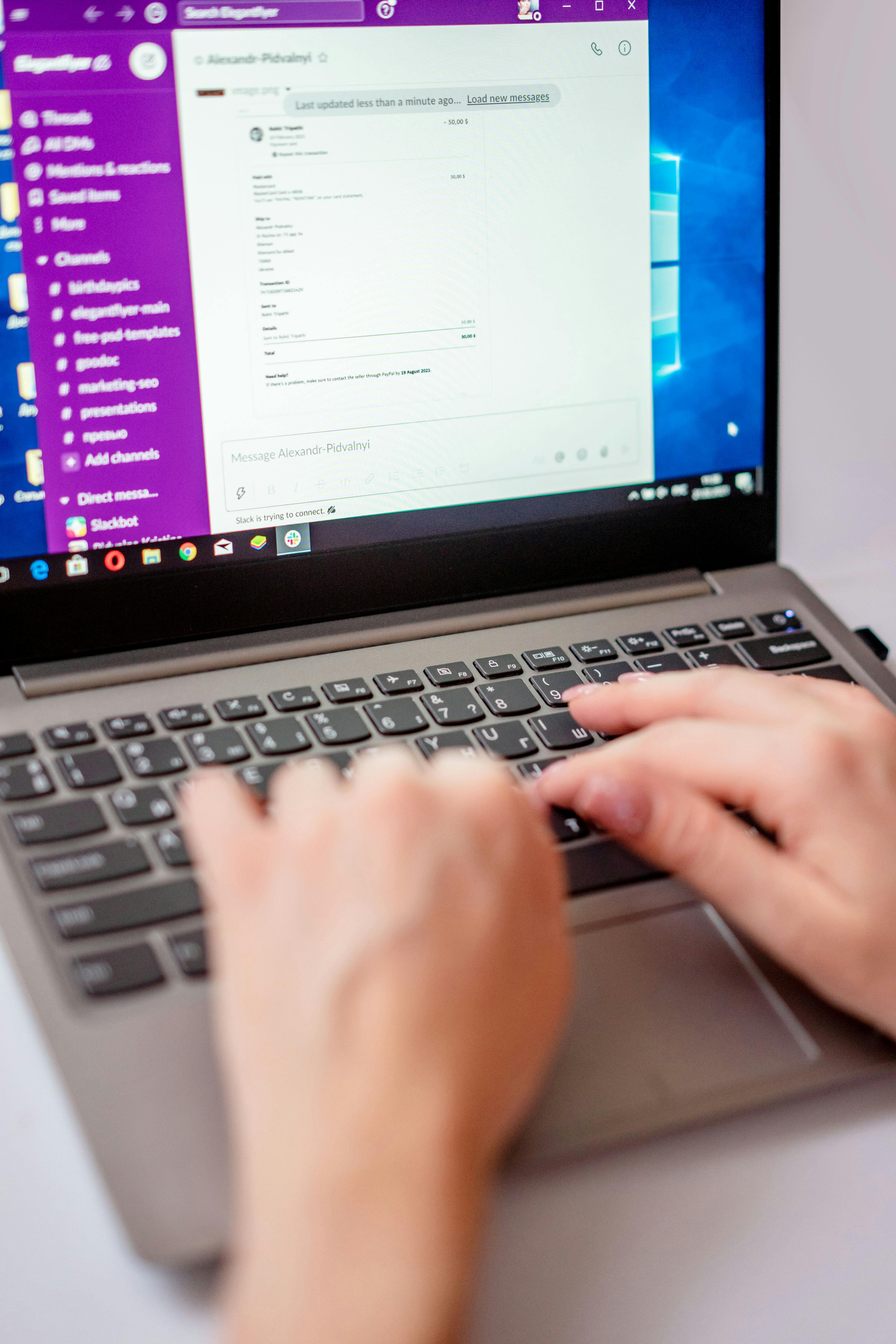 Close-Up Shot of a Person Using a Laptop on Wooden Surface · Free Stock ...