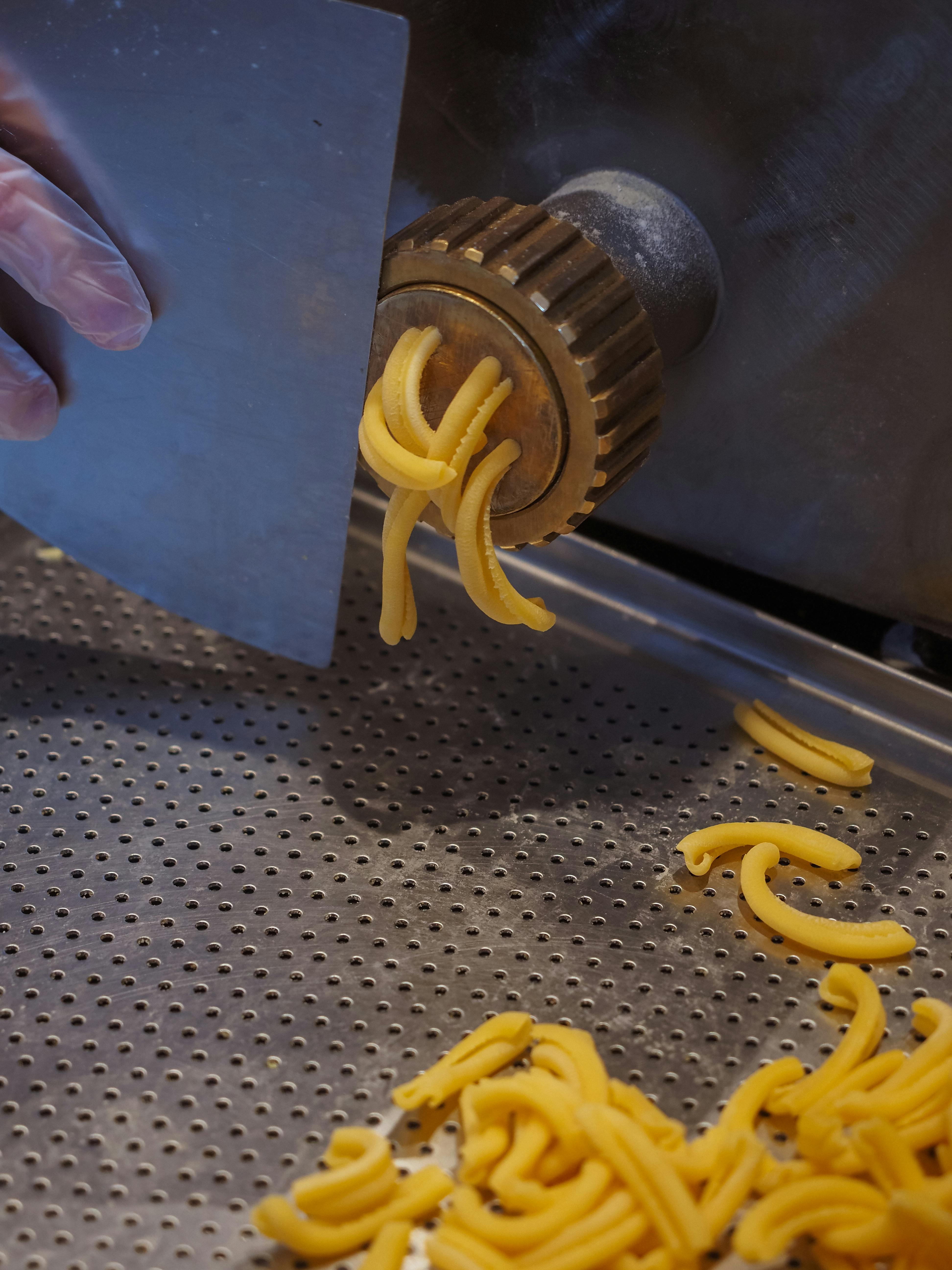 Close-up of a Person Making Pasta in a Pasta Machine · Free Stock Photo