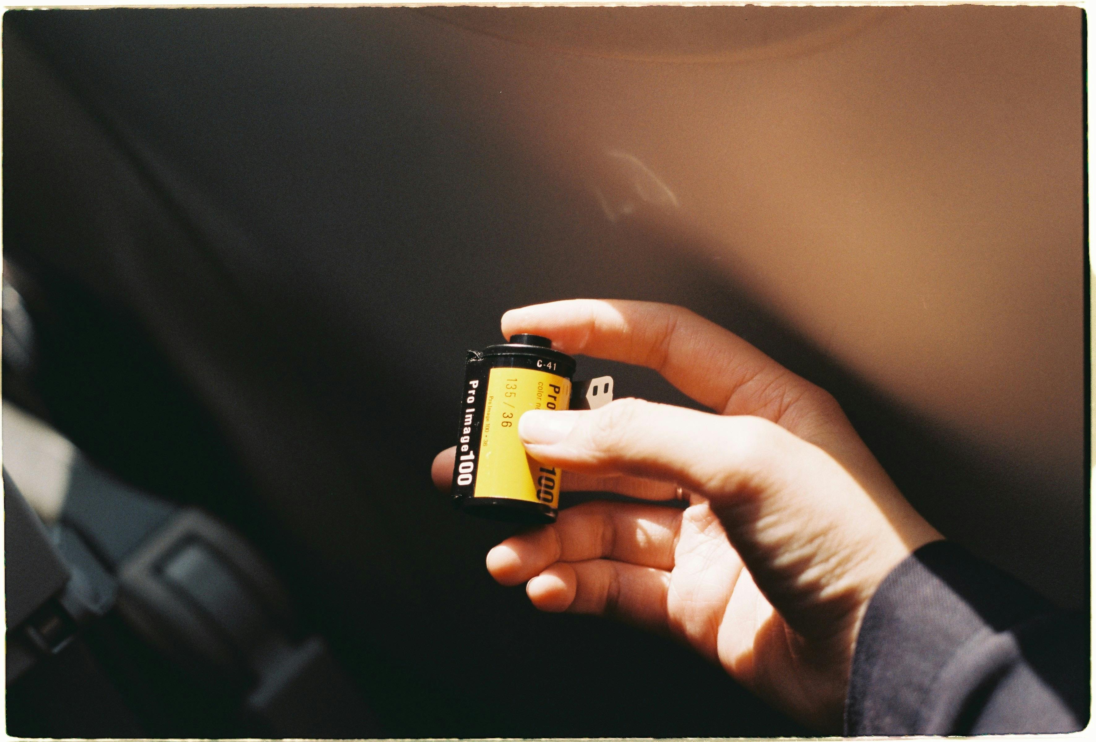 A Person Holding Polaroid Color Film Box · Free Stock Photo
