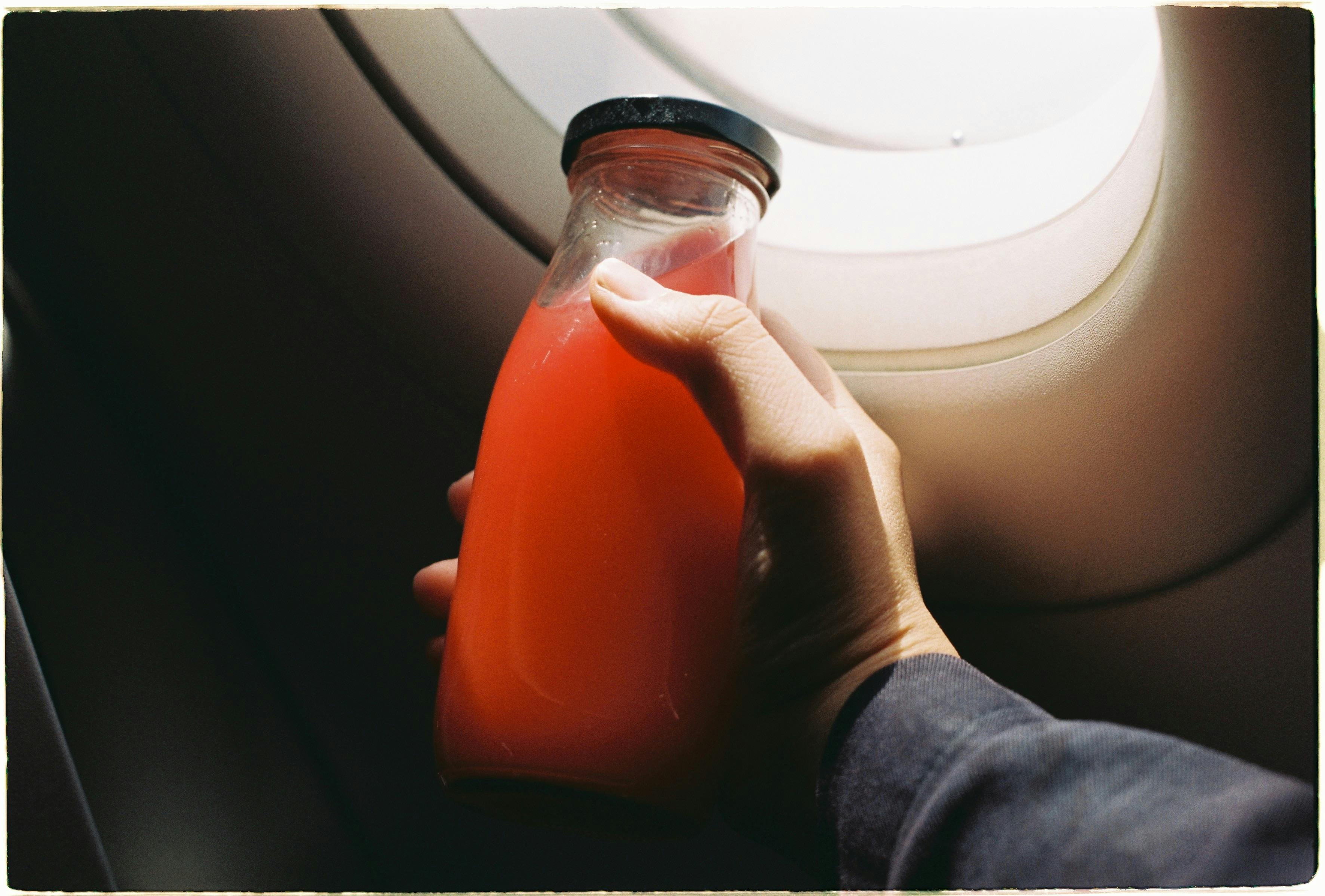 A Person's Hand Holding a Drink · Free Stock Photo
