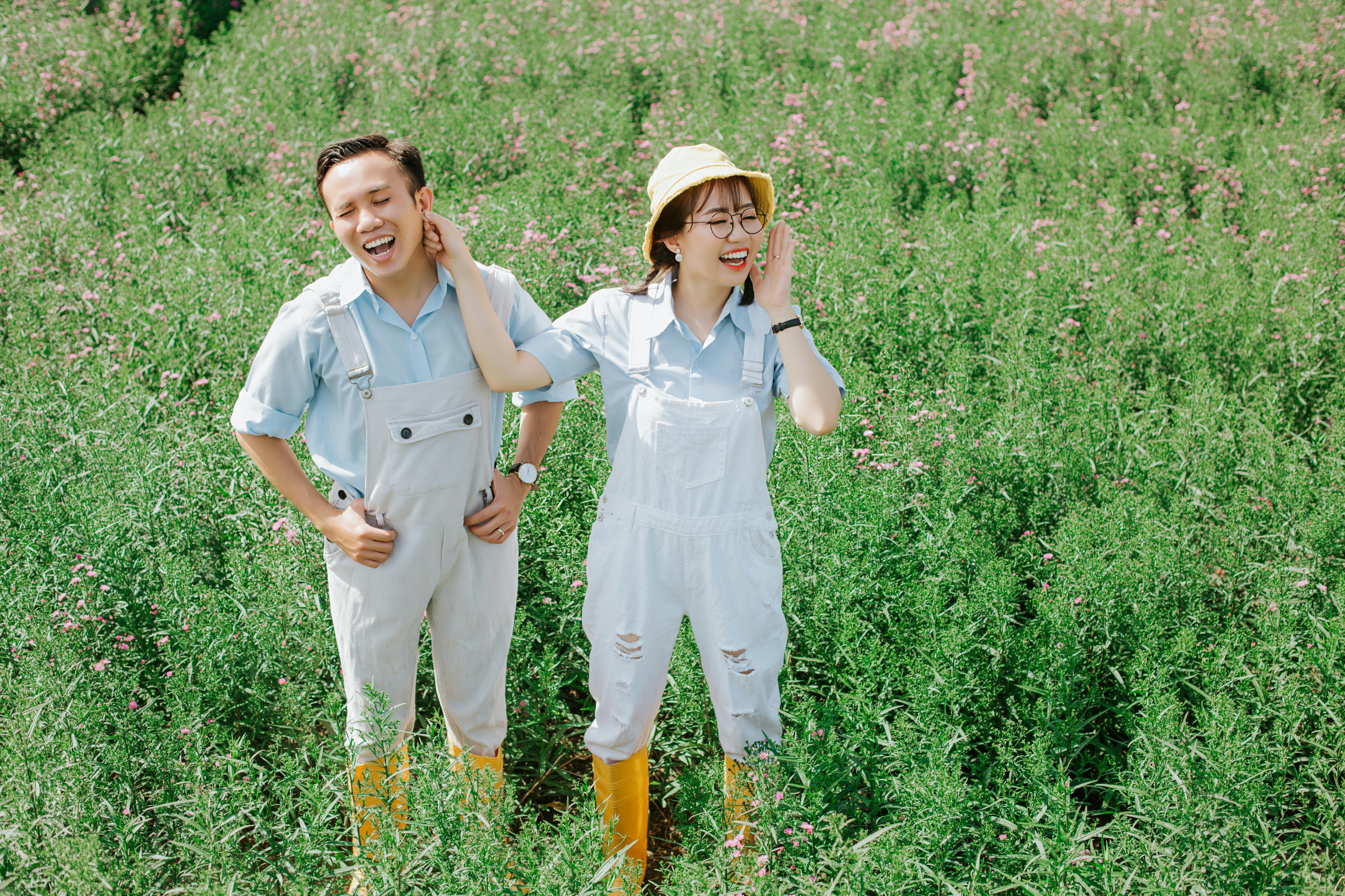 A Couple in Matching Jumpers on a Field · Free Stock Photo
