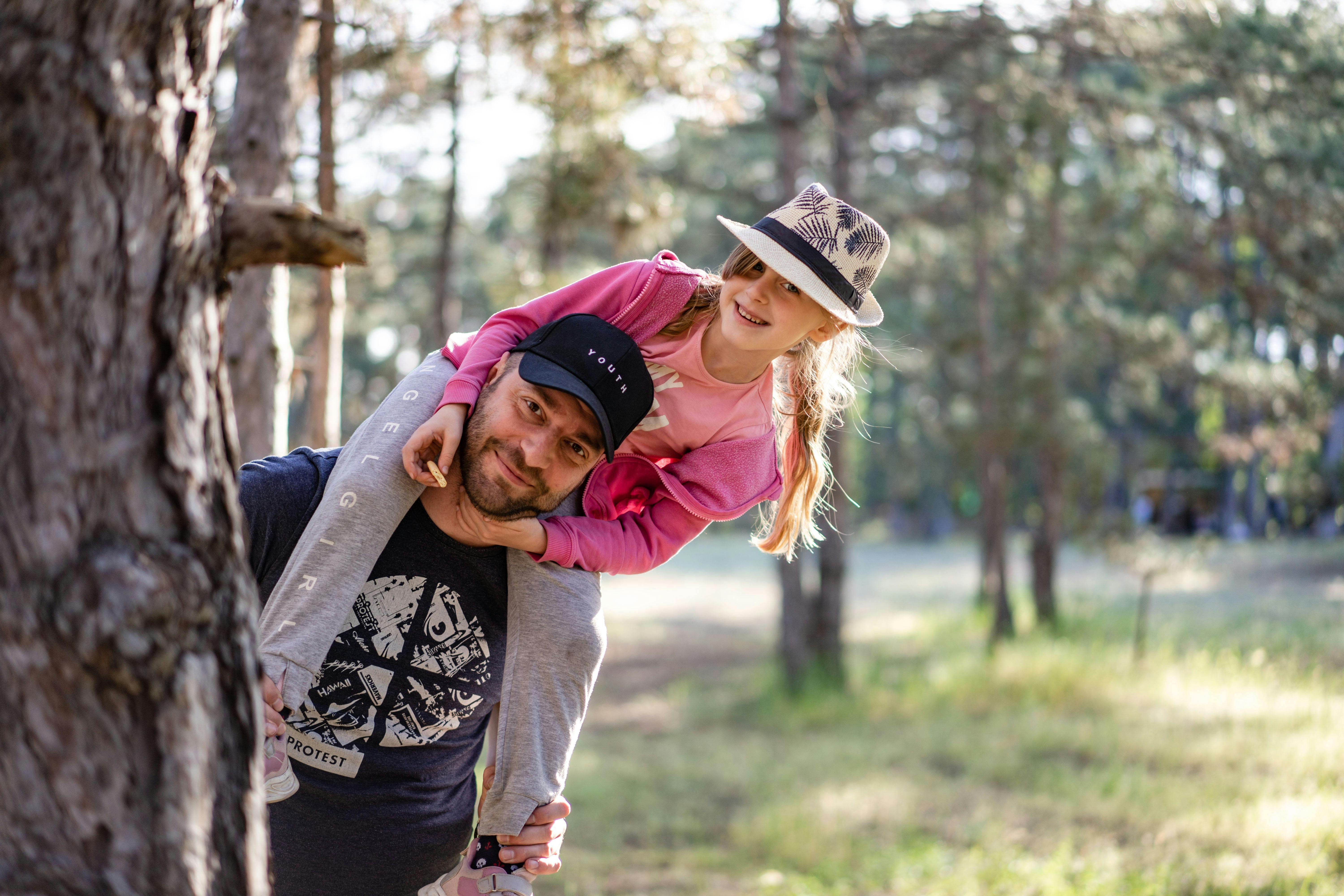 A Woman Riding a Man's Shoulder · Free Stock Photo