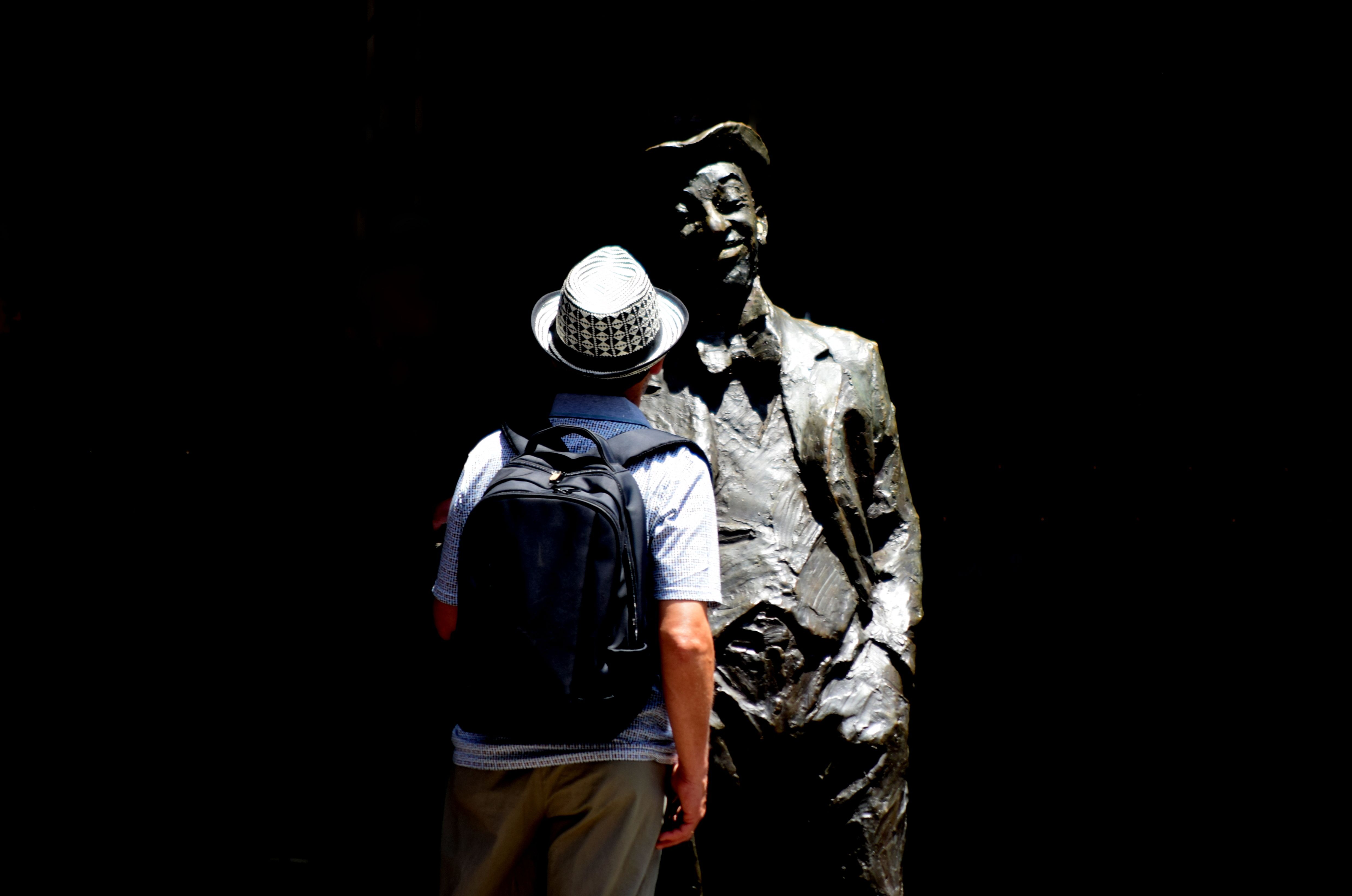 Man Standing in Front of Statue Photo · Free Stock Photo