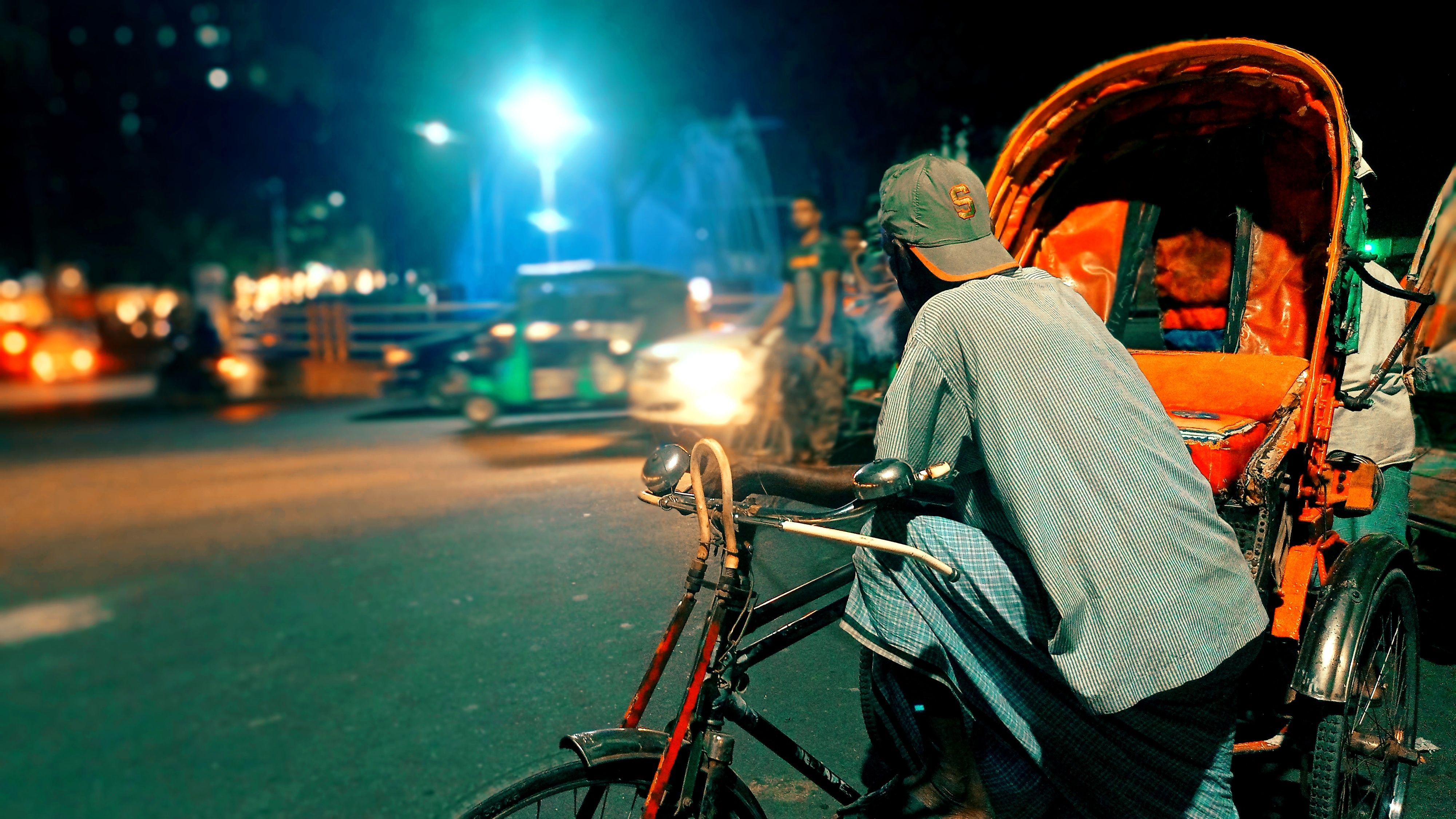 Man Standing Beside a Cycle Rickshaw Waiting during Nighttime · Free ...