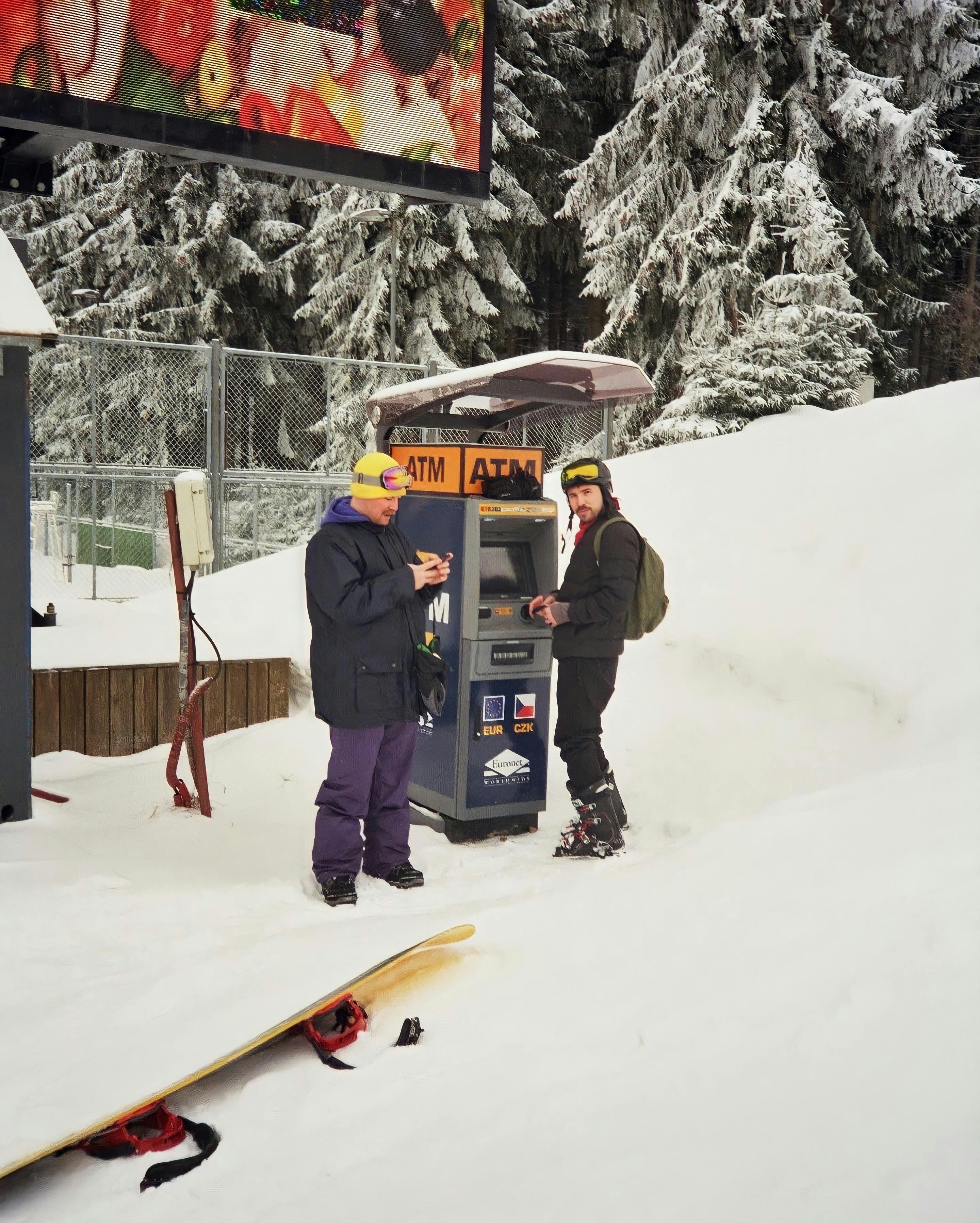 Men Next to an ATM Machine in a Ski Resort · Free Stock Photo