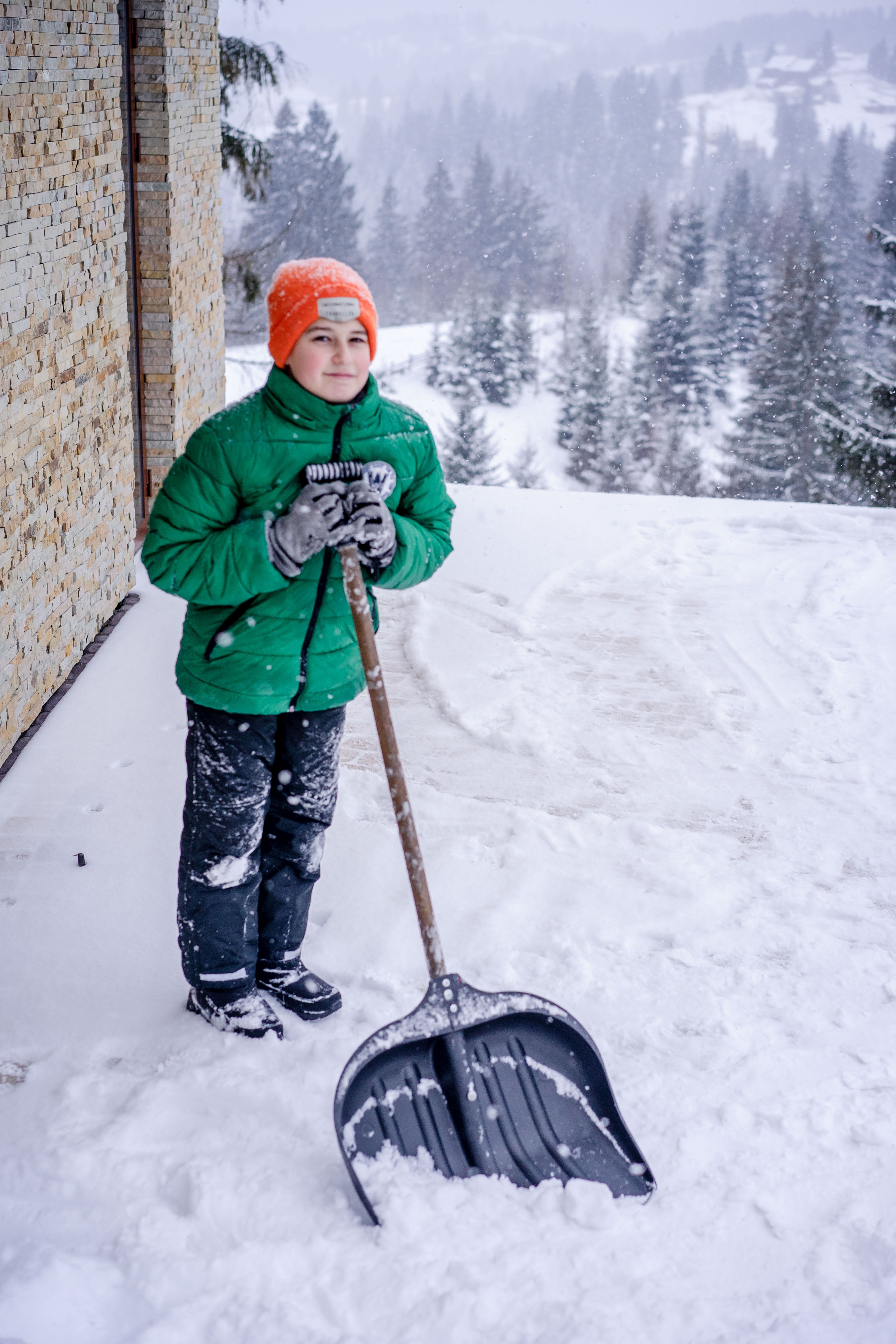 People Shoveling Snow Off a Roof · Free Stock Photo