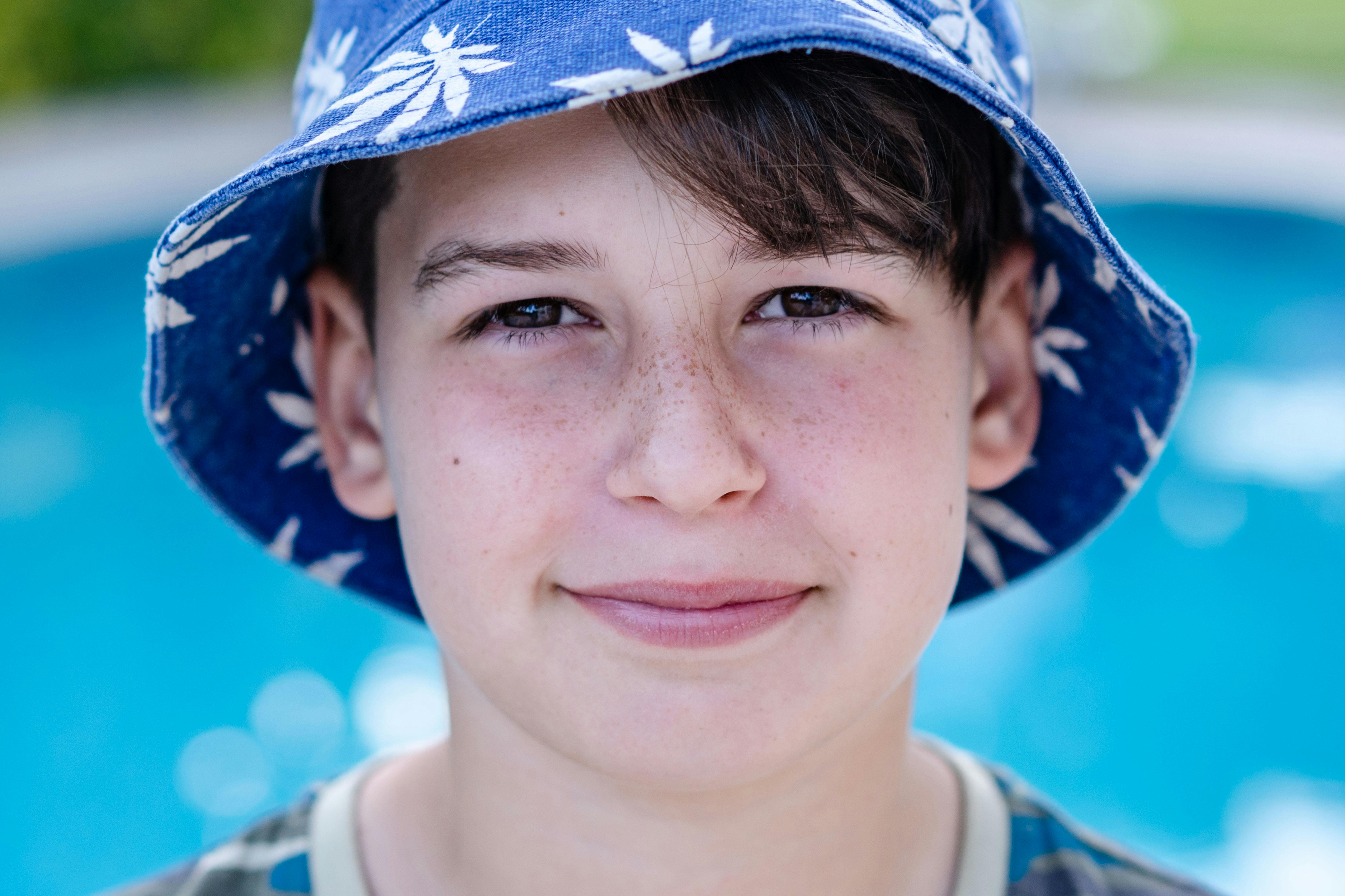 Portrait of Smiling Boy Wearing Bucket Hat · Free Stock Photo