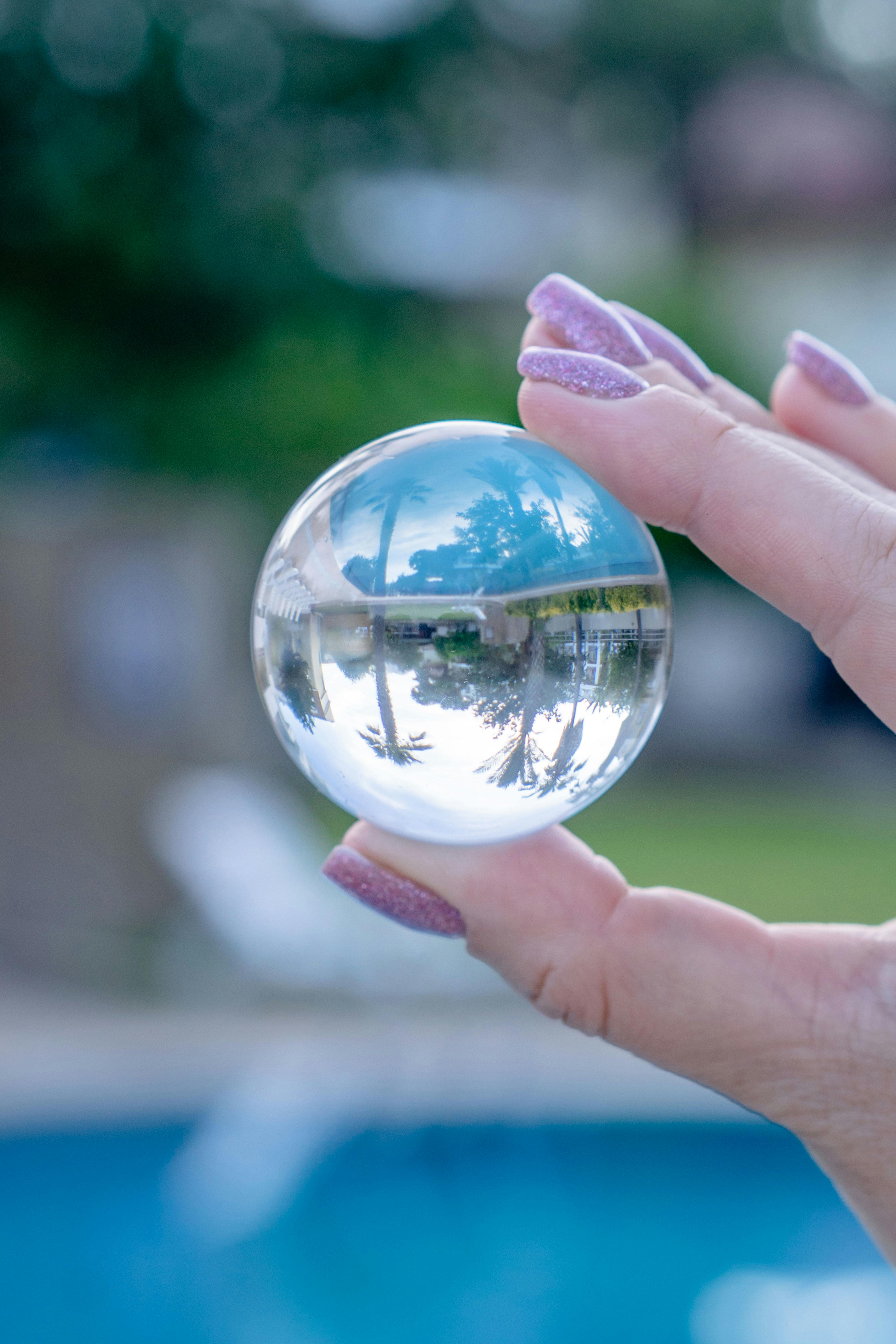 Person Holding Clear Glass Ball · Free Stock Photo