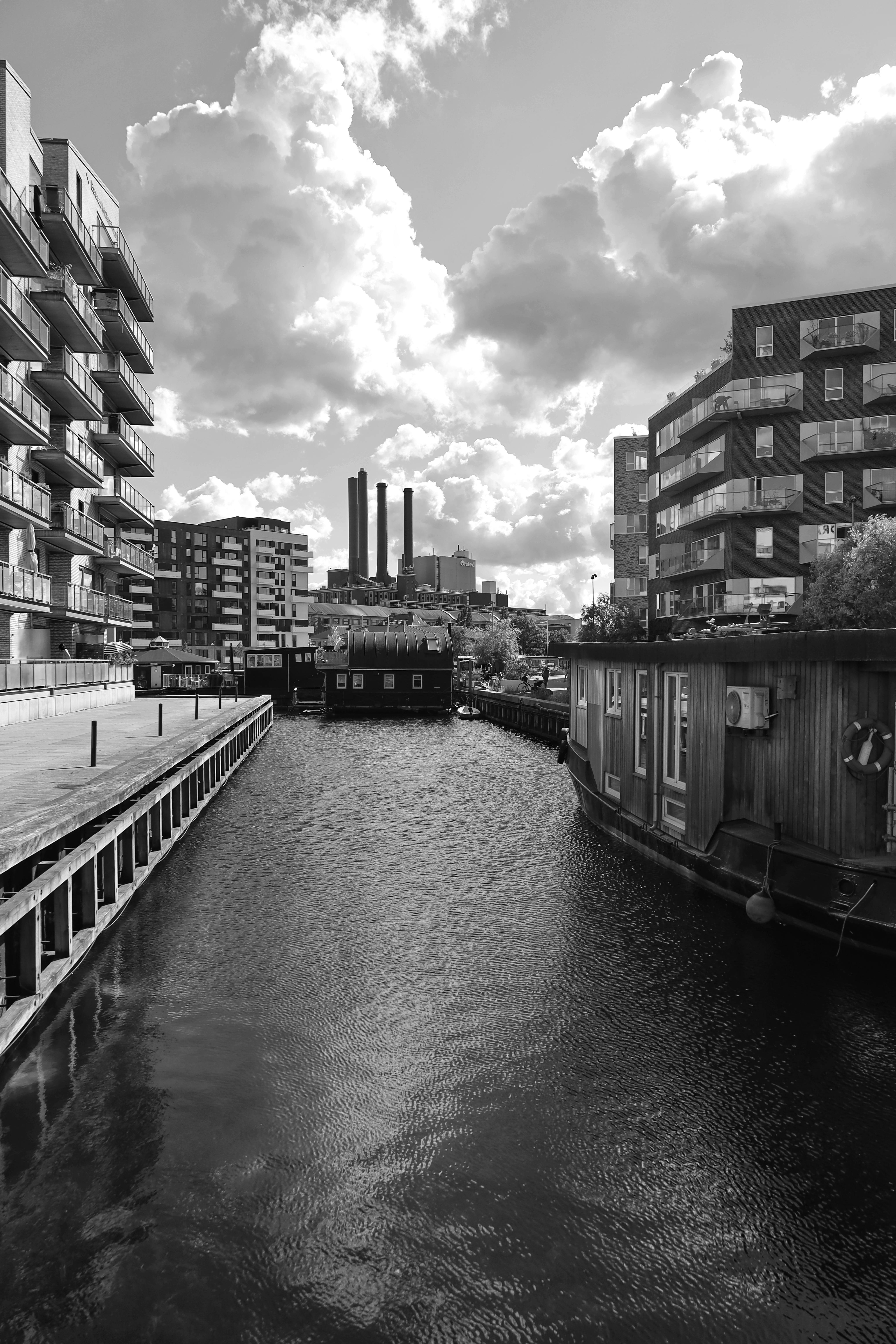Grayscale Photo of River in Between Buildings · Free Stock Photo