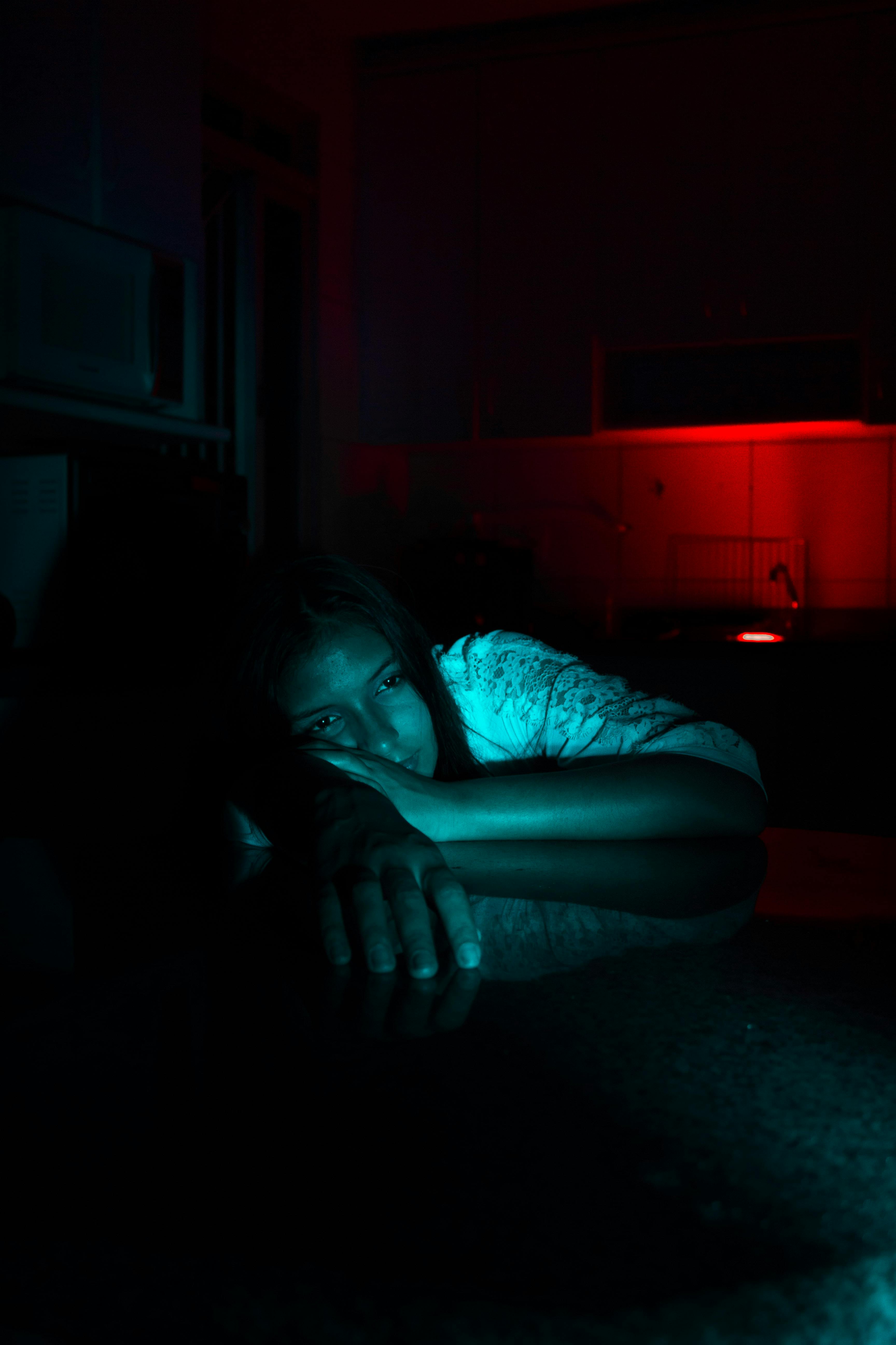 Woman Lying Down on Dark · Free Stock Photo