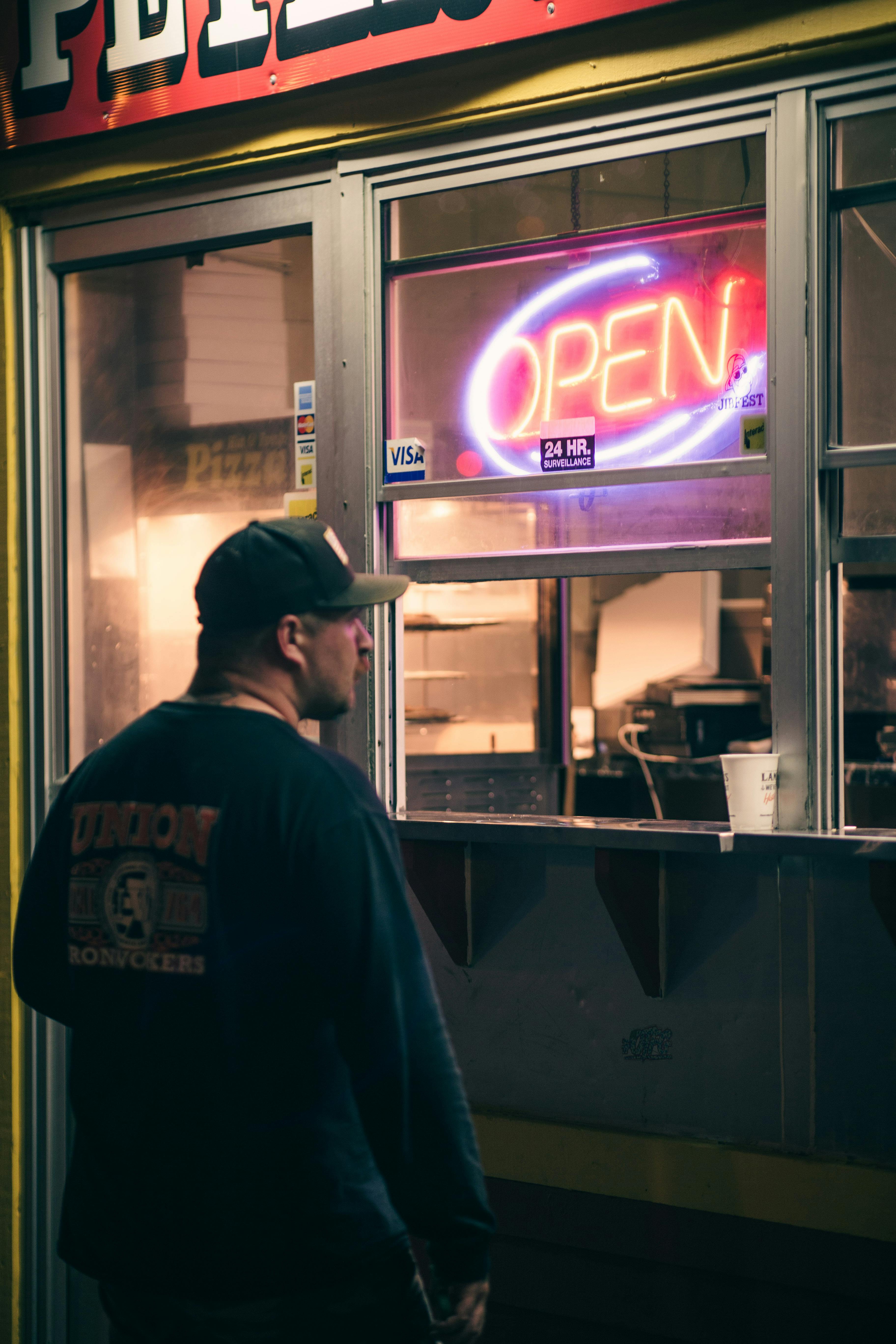 A Man Standing in Front of the Glass Window · Free Stock Photo