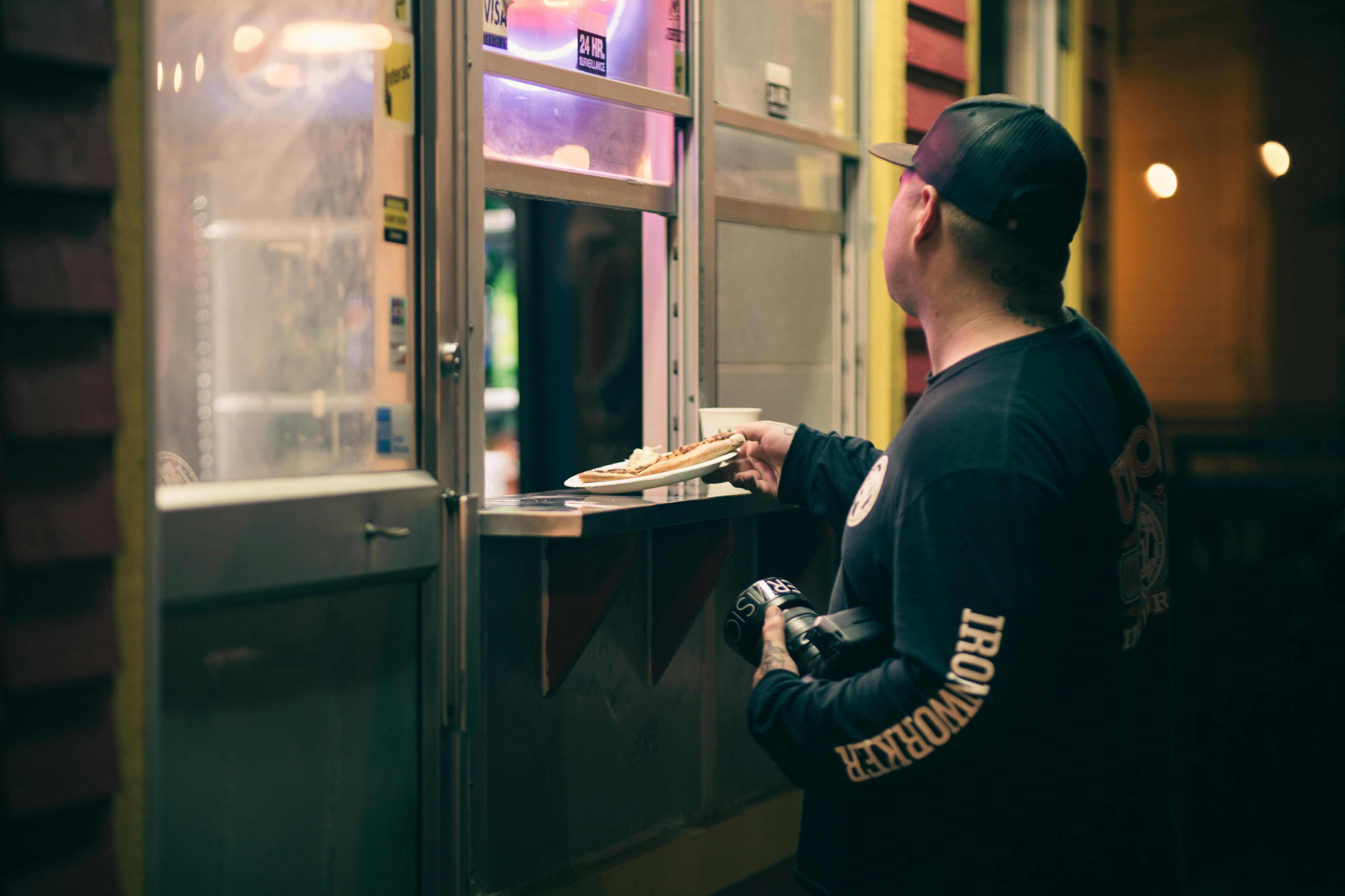 A Man Ordering at the Counter · Free Stock Photo