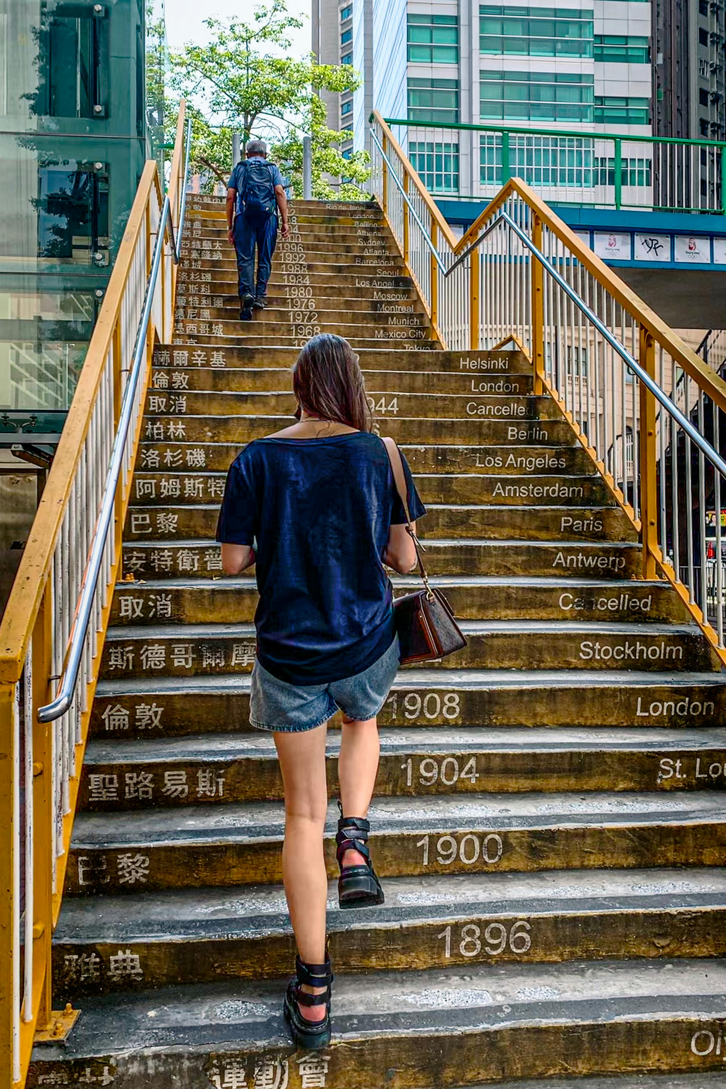 Low-Angle Shot of Two People Walking Up Stairs · Free Stock Photo