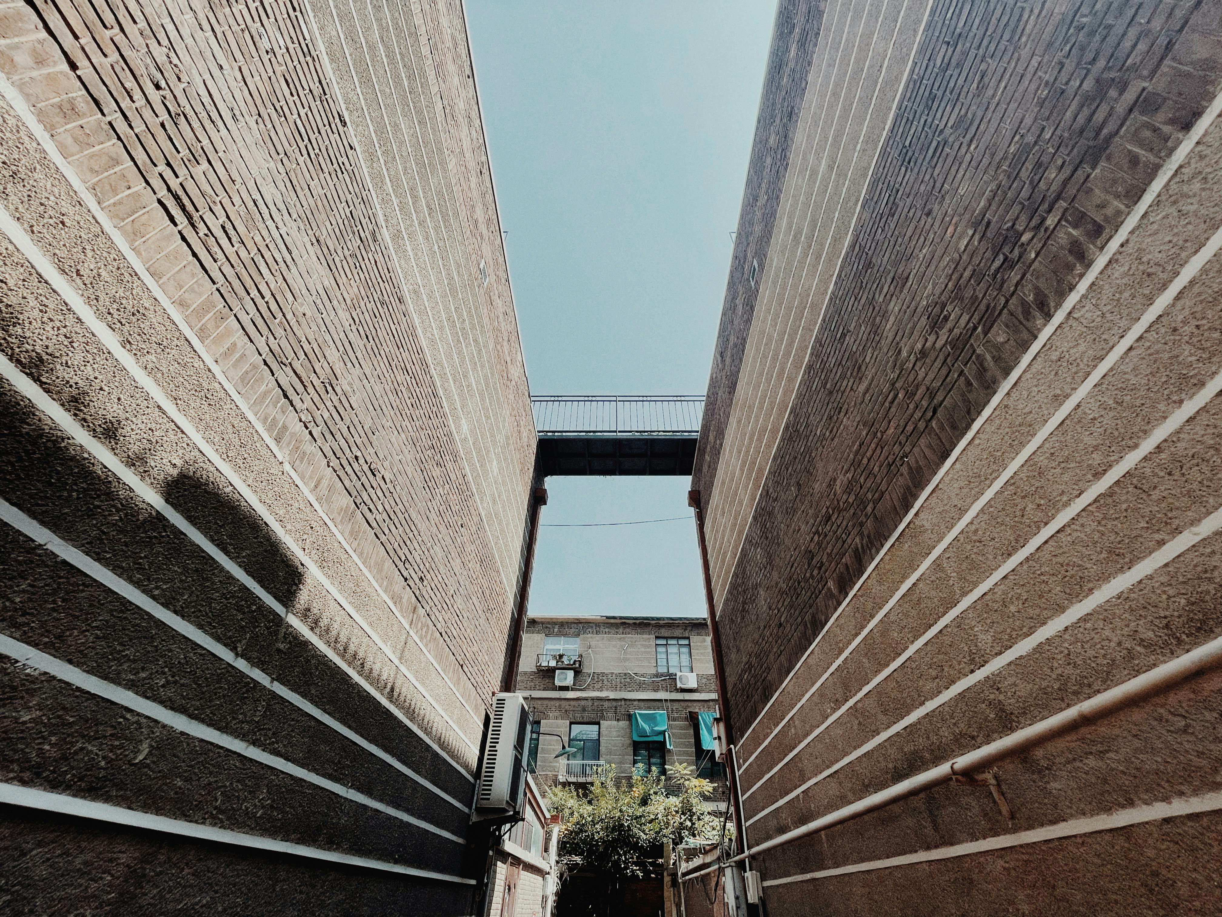 Residential Building Seen between Concrete Walls · Free Stock Photo