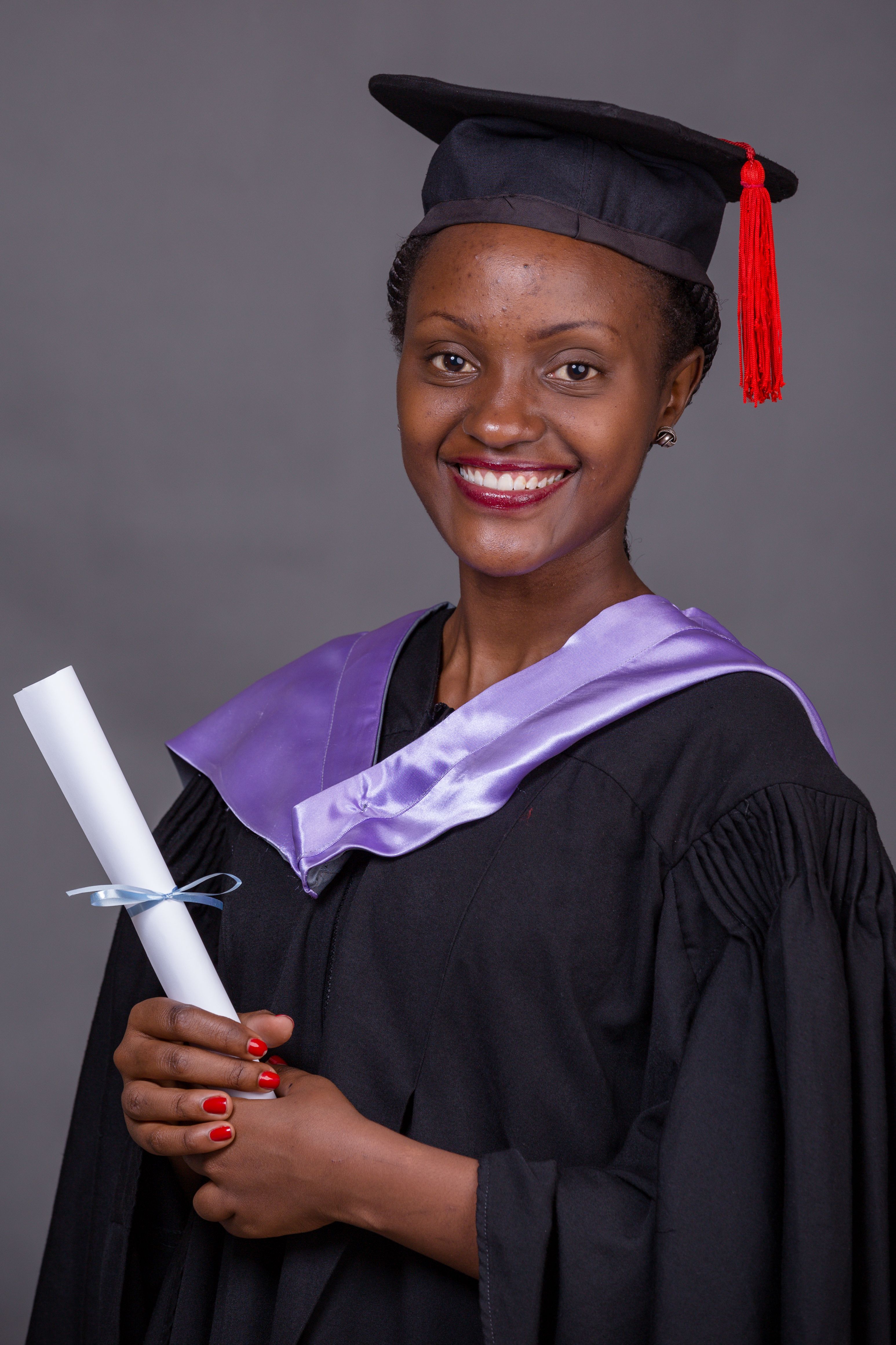 Woman in Graduation Gown Smiling · Free Stock Photo