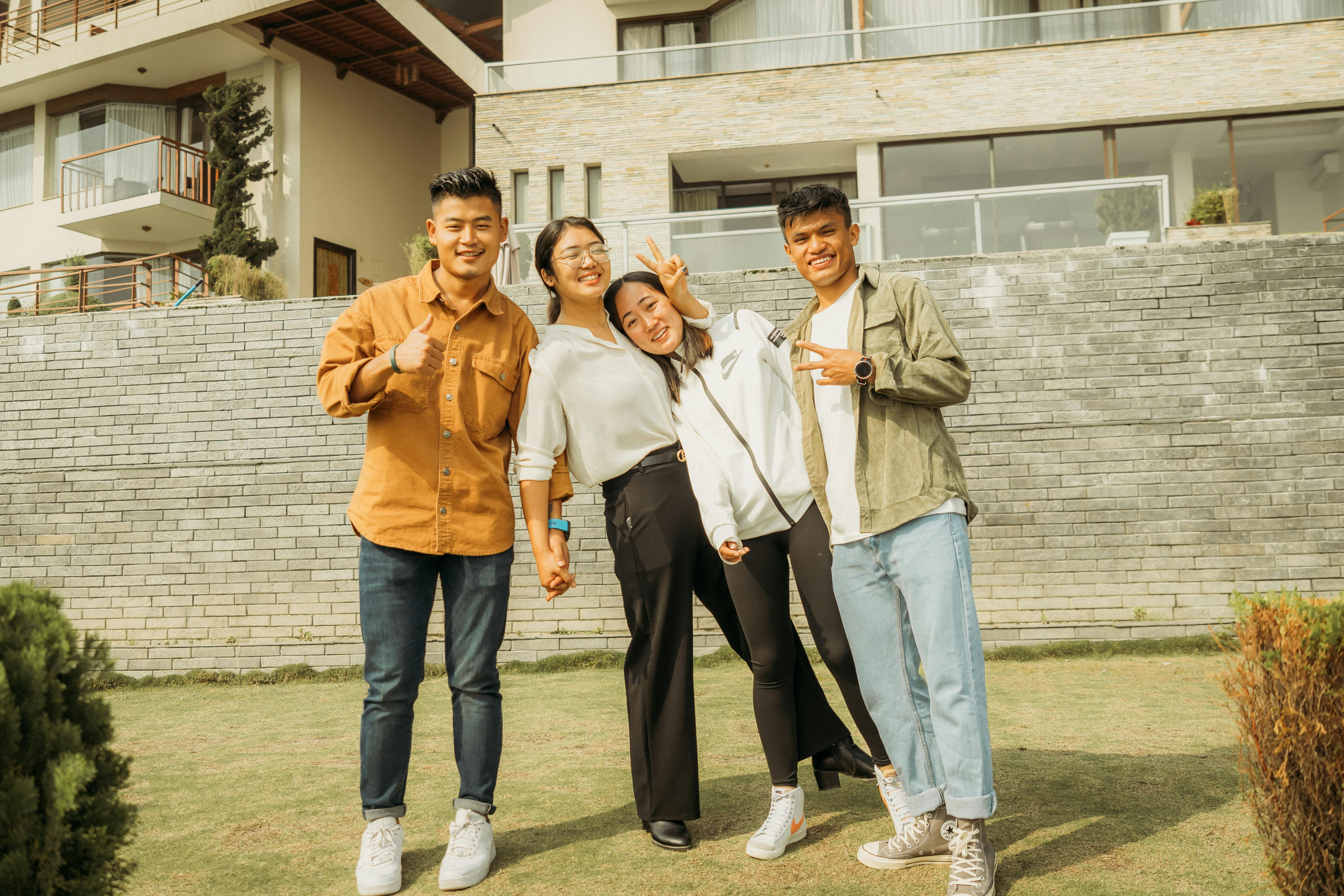 Group of People Smiling and Doing Peace Sign · Free Stock Photo