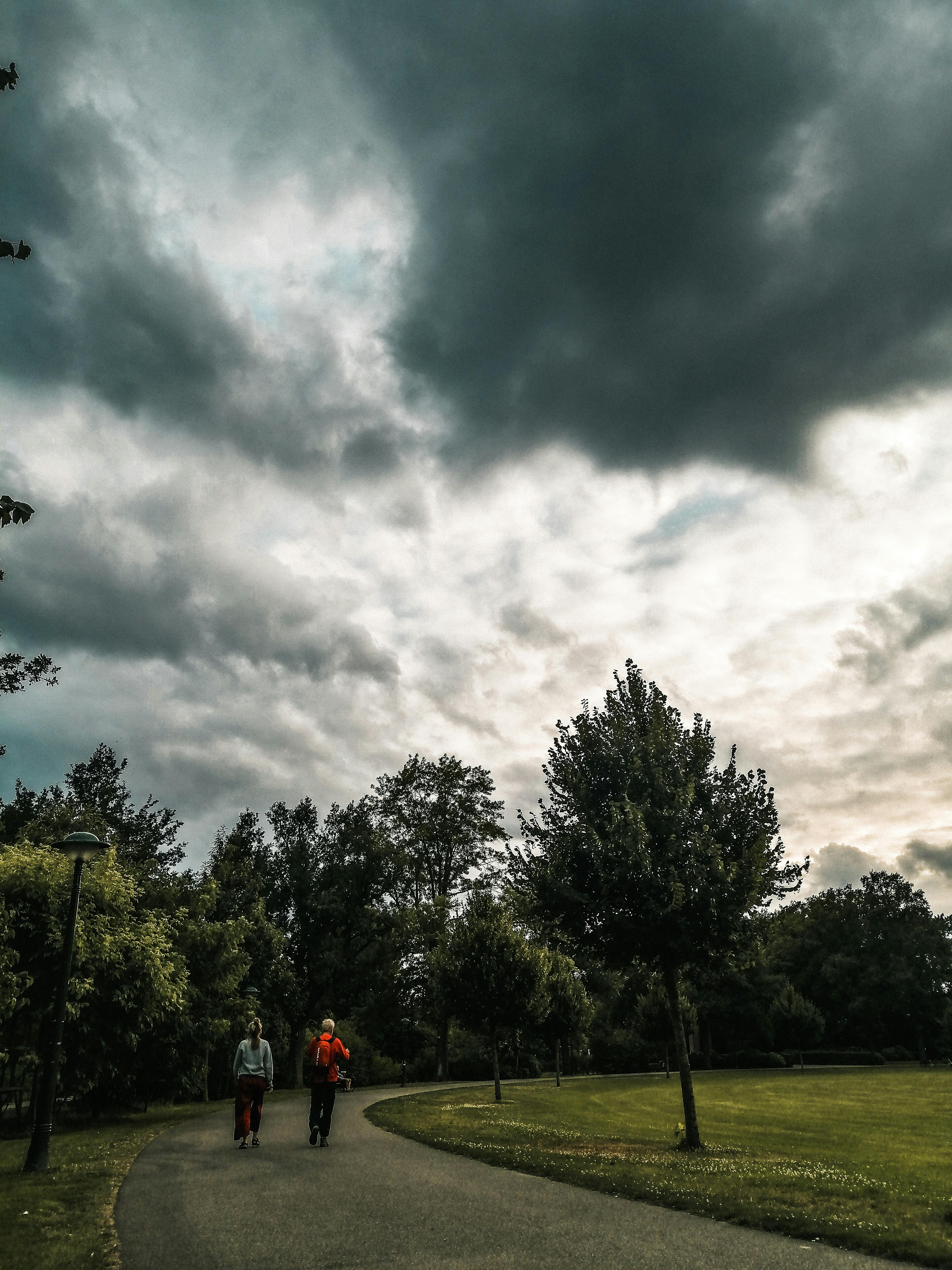 Two People Walking on the Pathway under the Cloudy Sky · Free Stock Photo