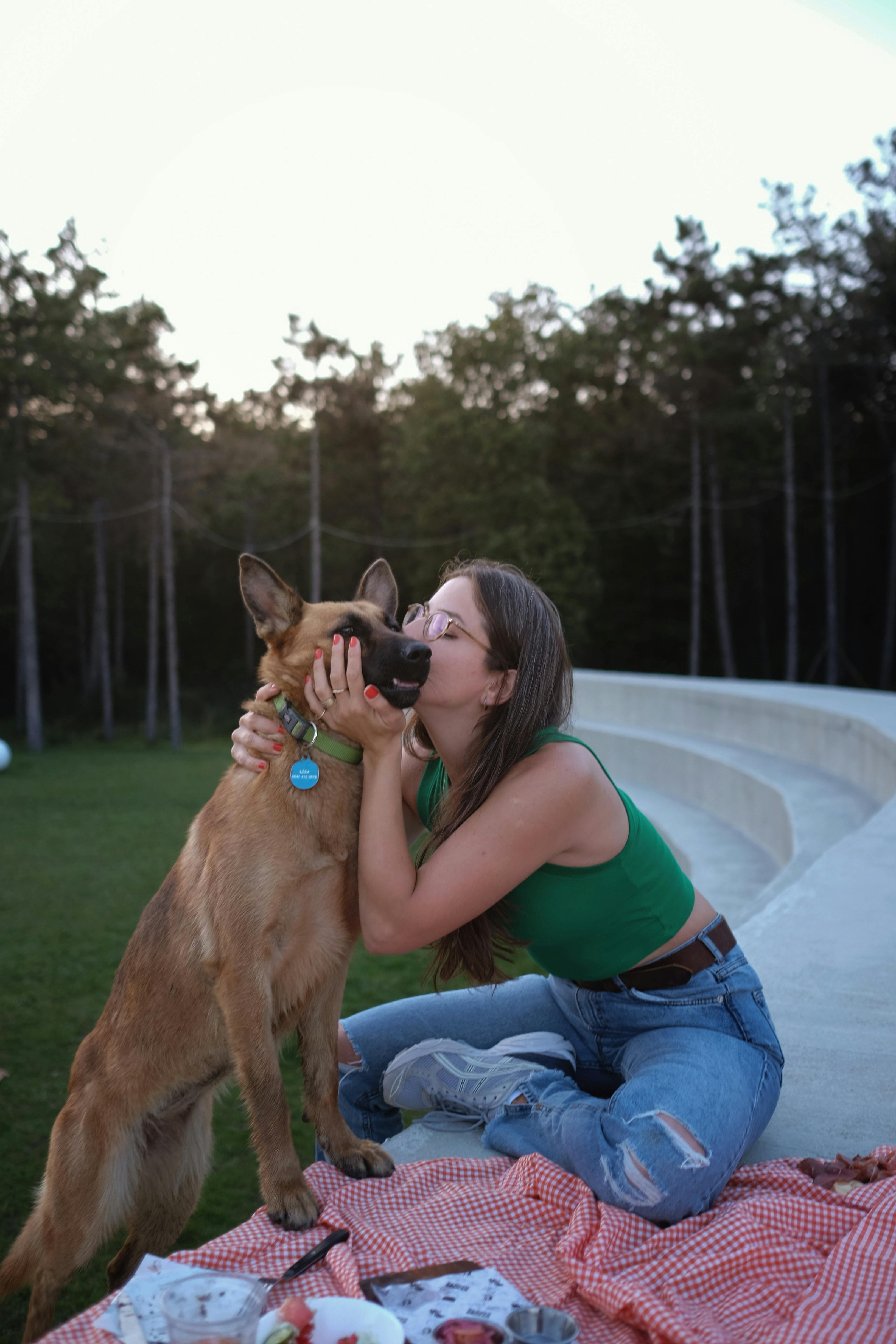 Woman Kissing Her Dog in a Park · Free Stock Photo