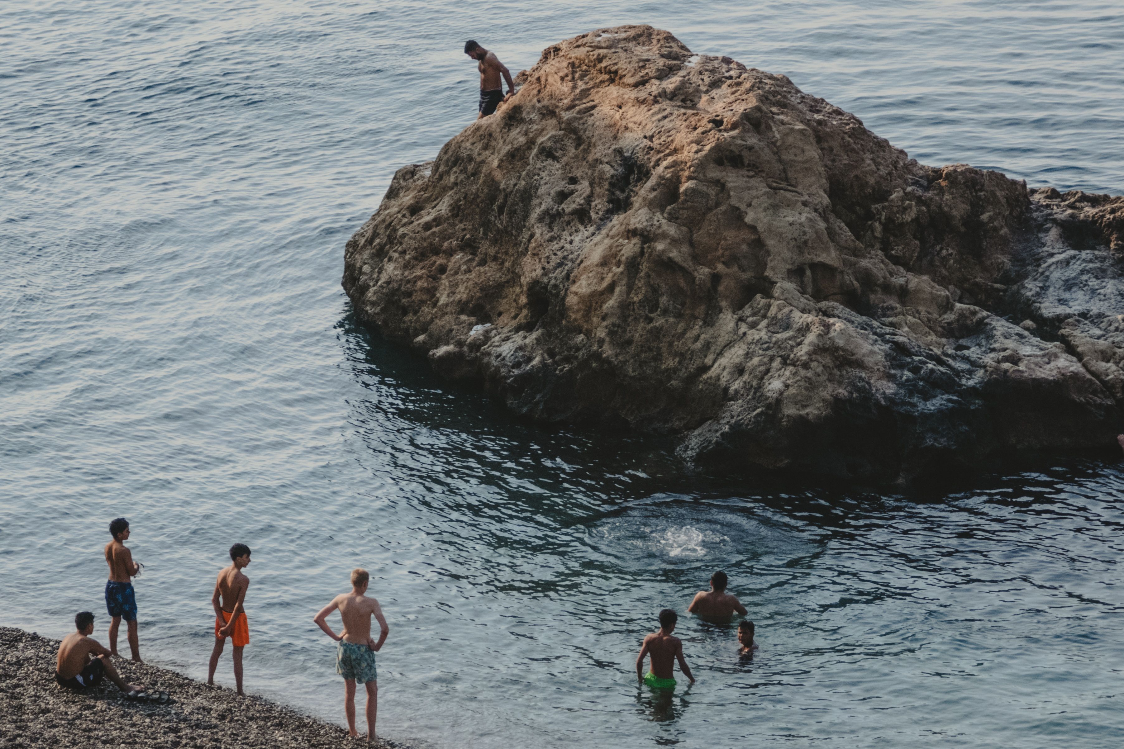 People Standing on Rock Formation · Free Stock Photo