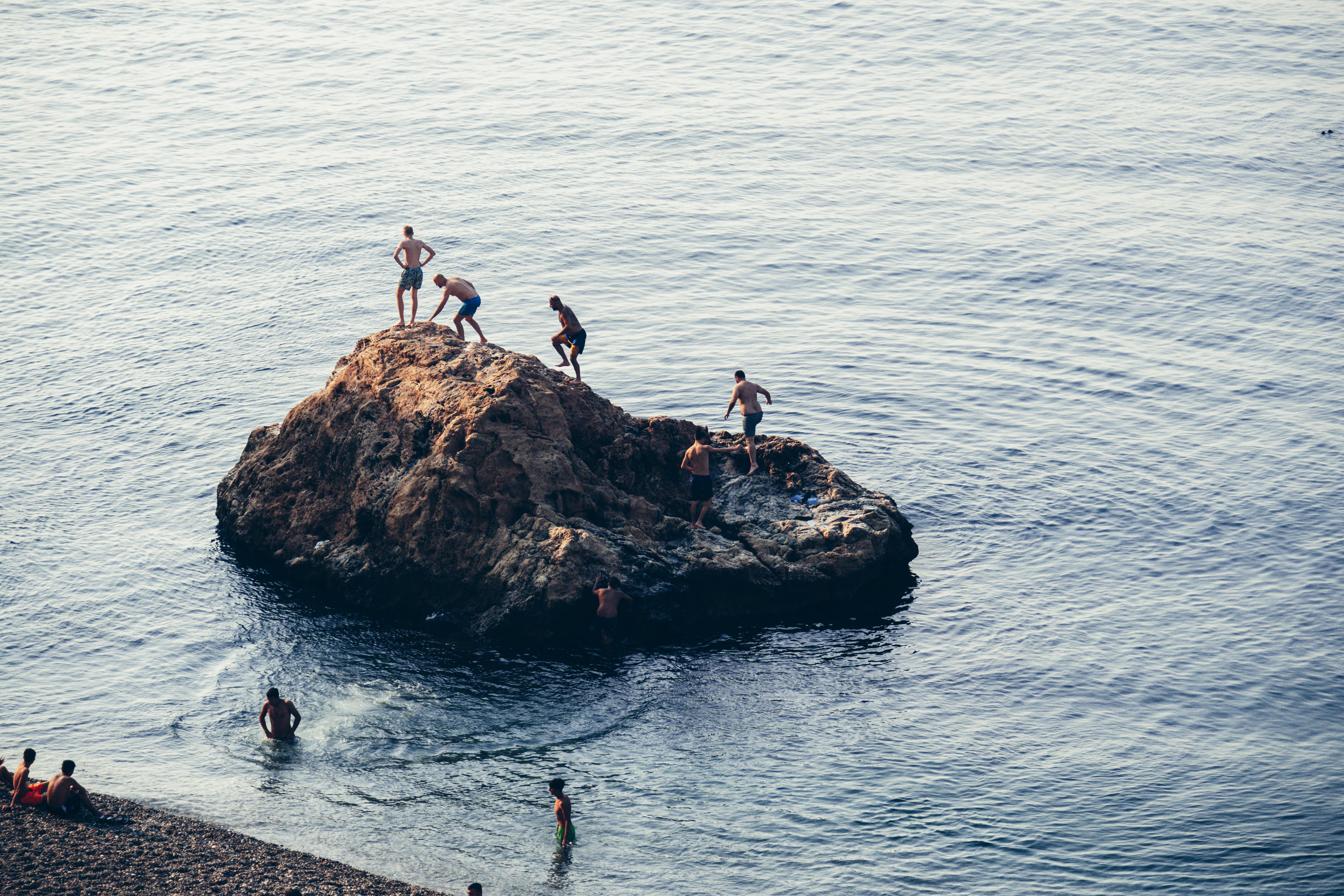 People Standing on Rock Formation · Free Stock Photo