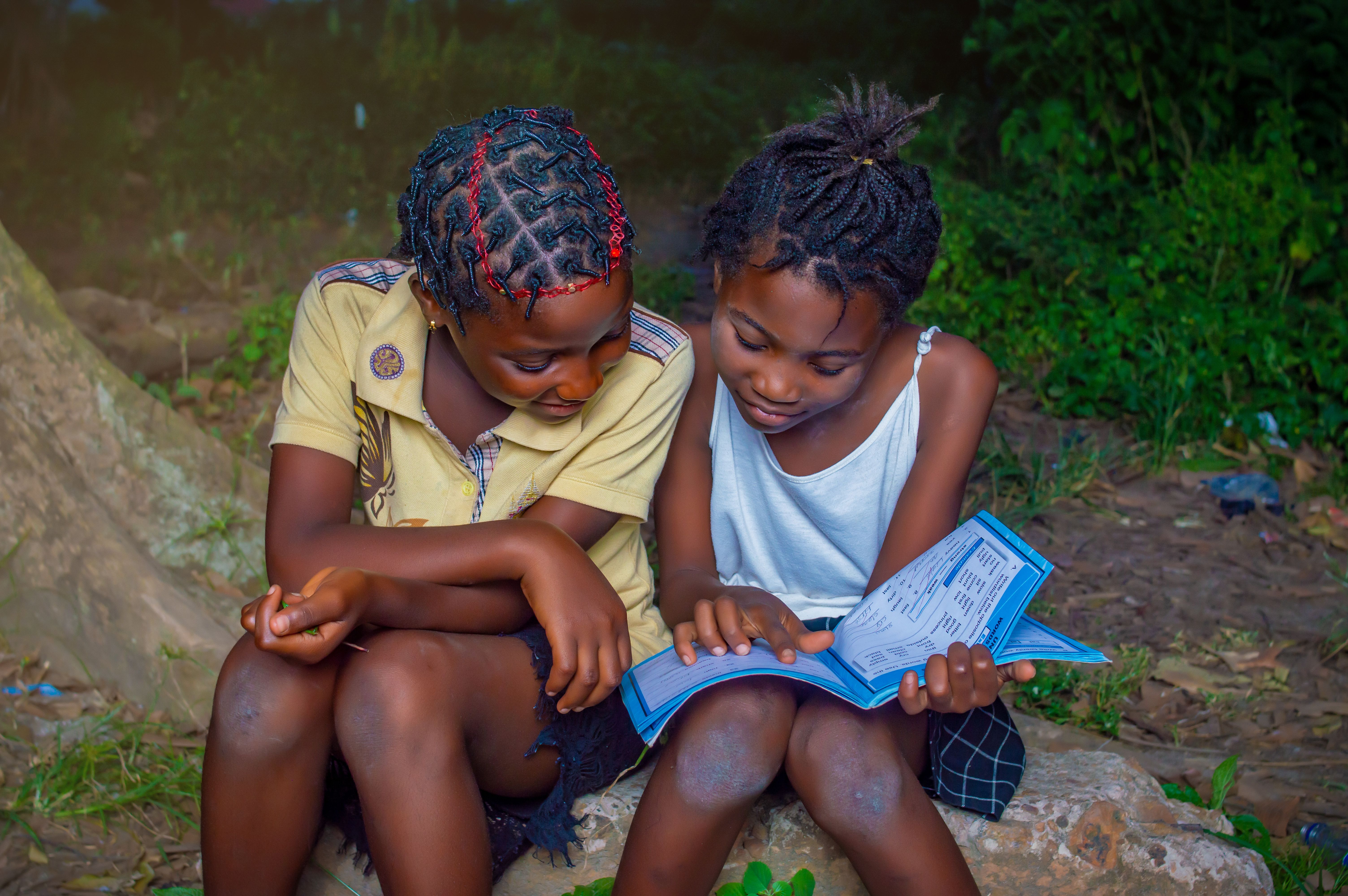 Girls Reading a Book Together · Free Stock Photo