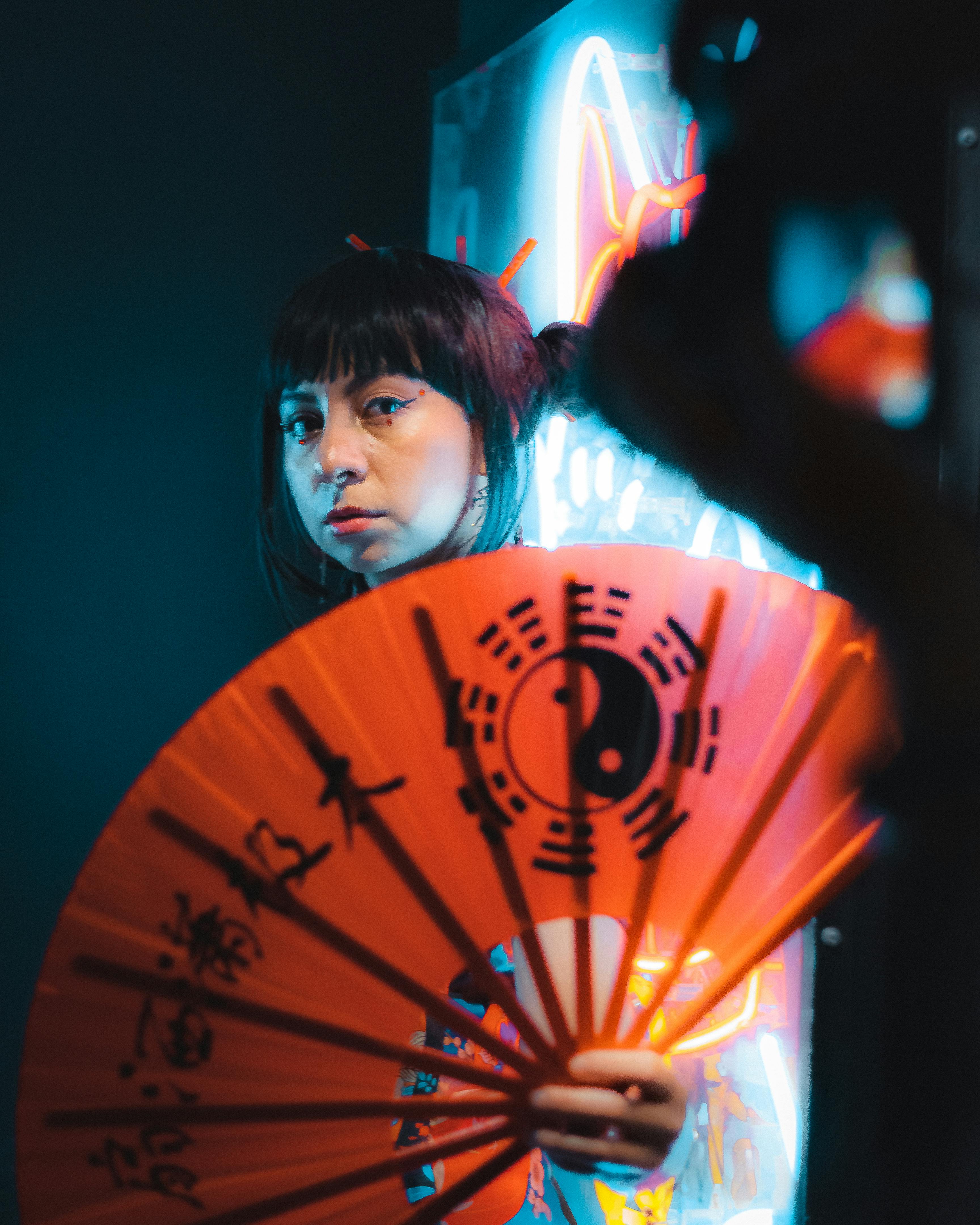Portrait of a Woman Holding a Hand Fan · Free Stock Photo