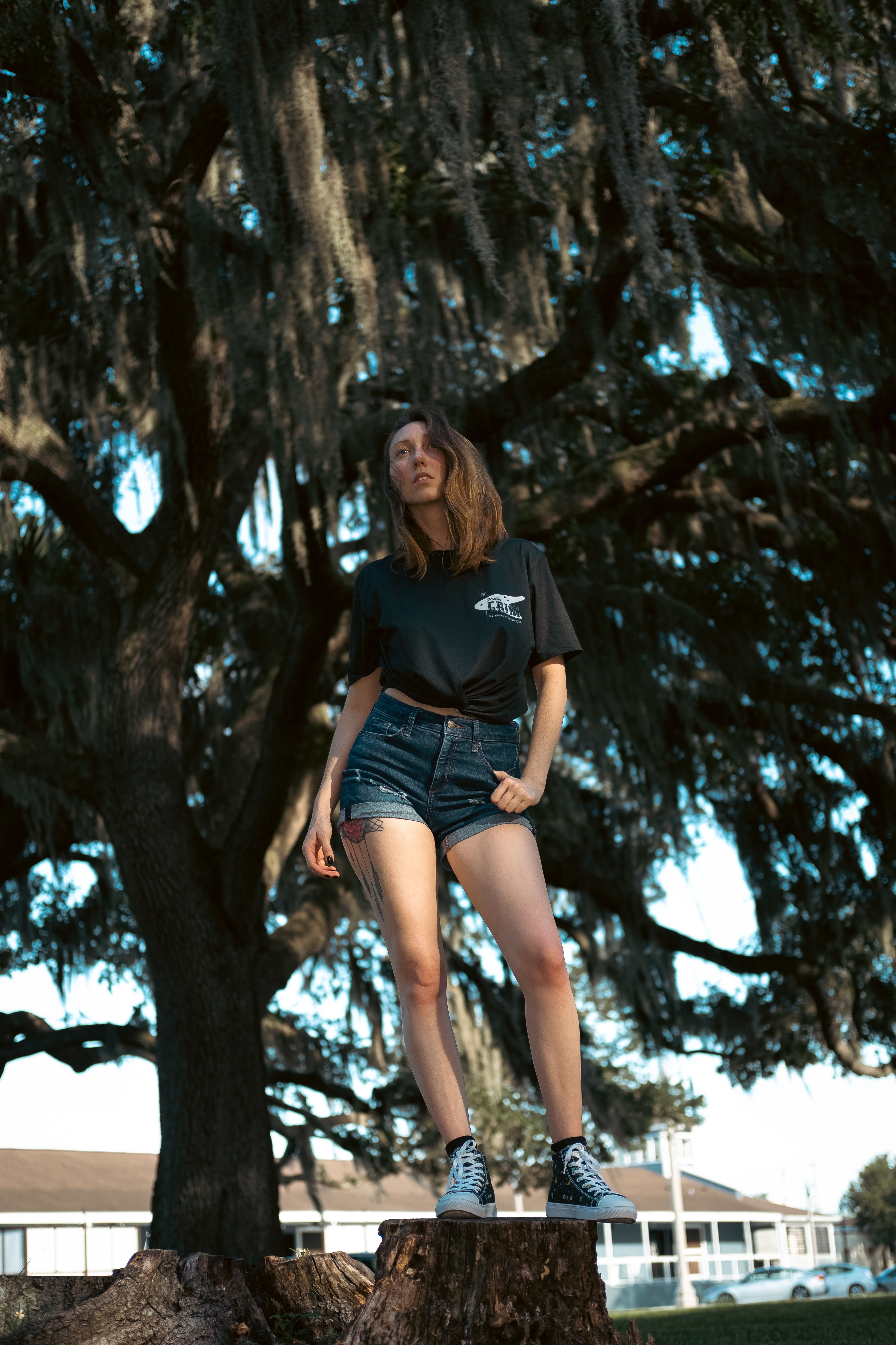 Woman in Black Crew Neck T-shirt and Blue Denim Jeans Standing on a ...