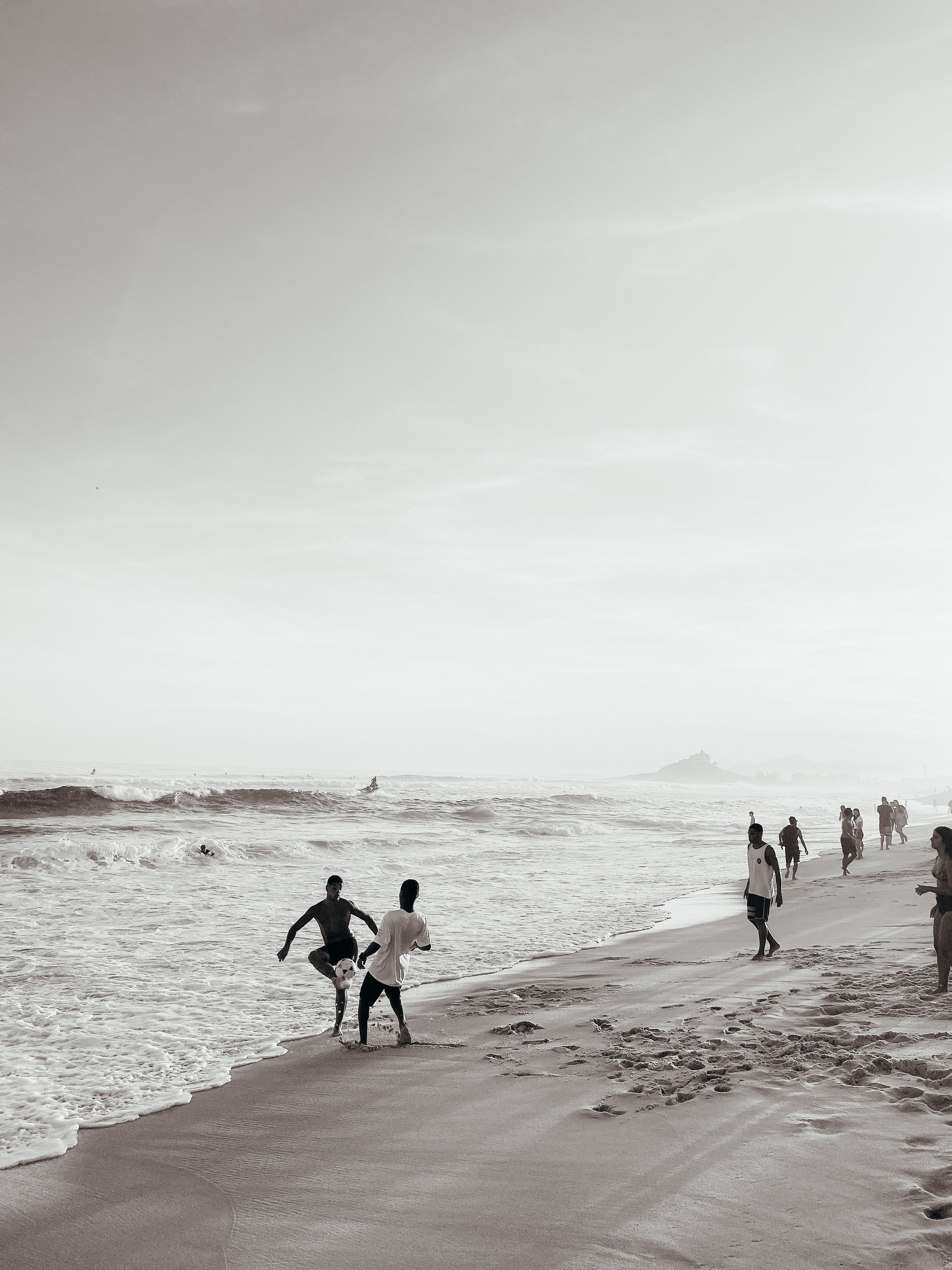 Sepia Toned Image of People Playing on a Sandy Beach · Free Stock Photo