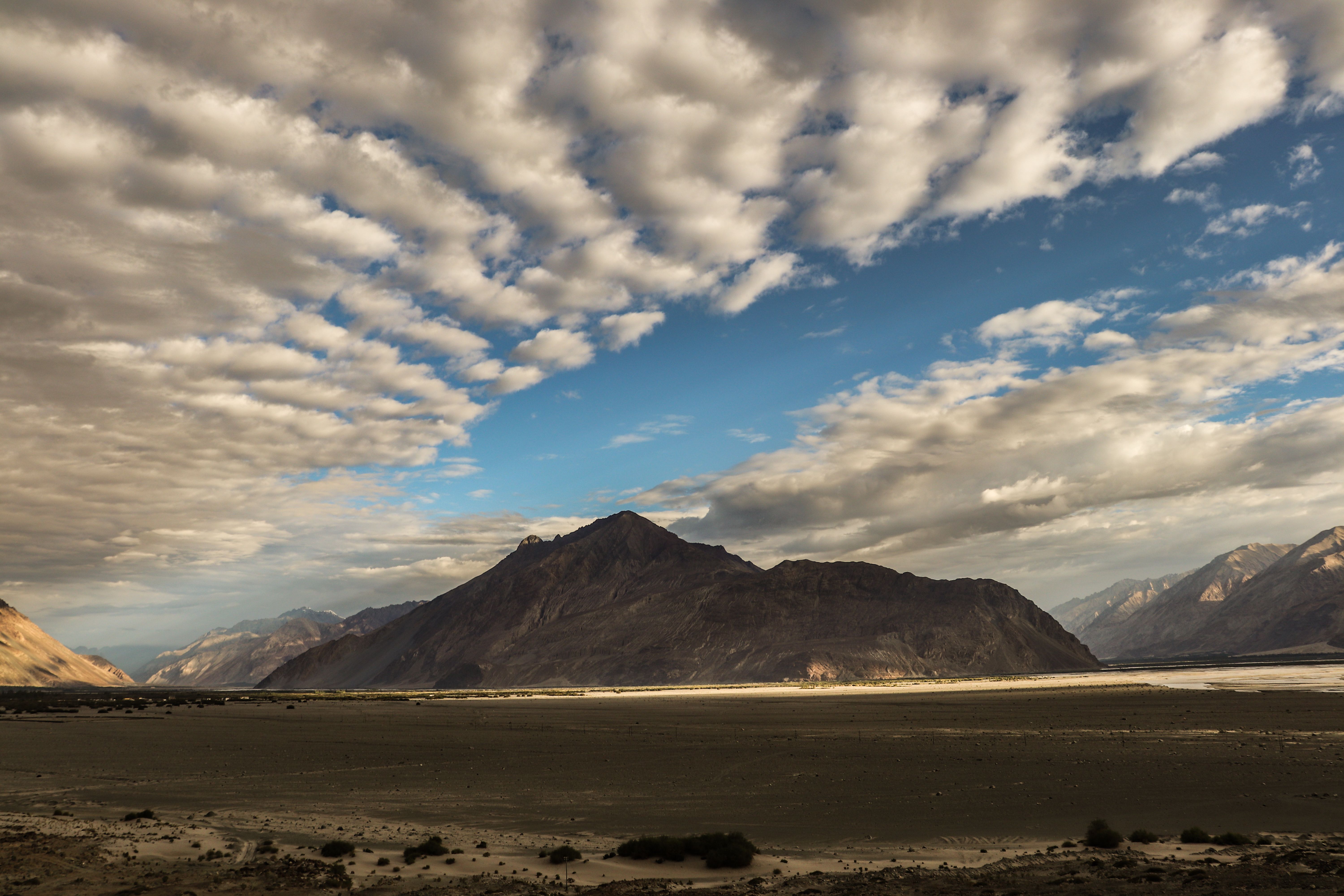 Landscape Scenery of Vast Plains Across the Mountains · Free Stock Photo