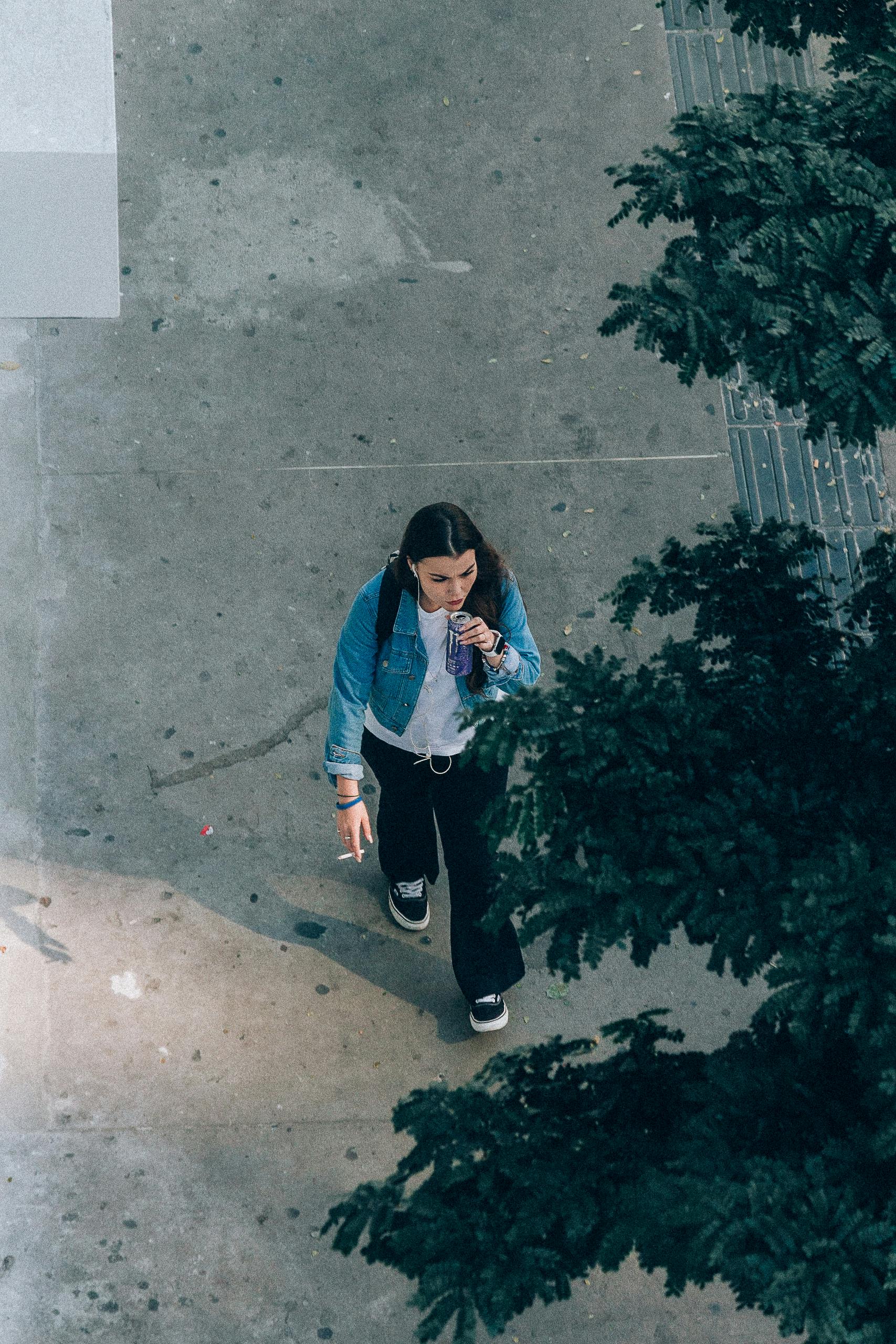 Woman in Denim Jacket Walking on the Street · Free Stock Photo
