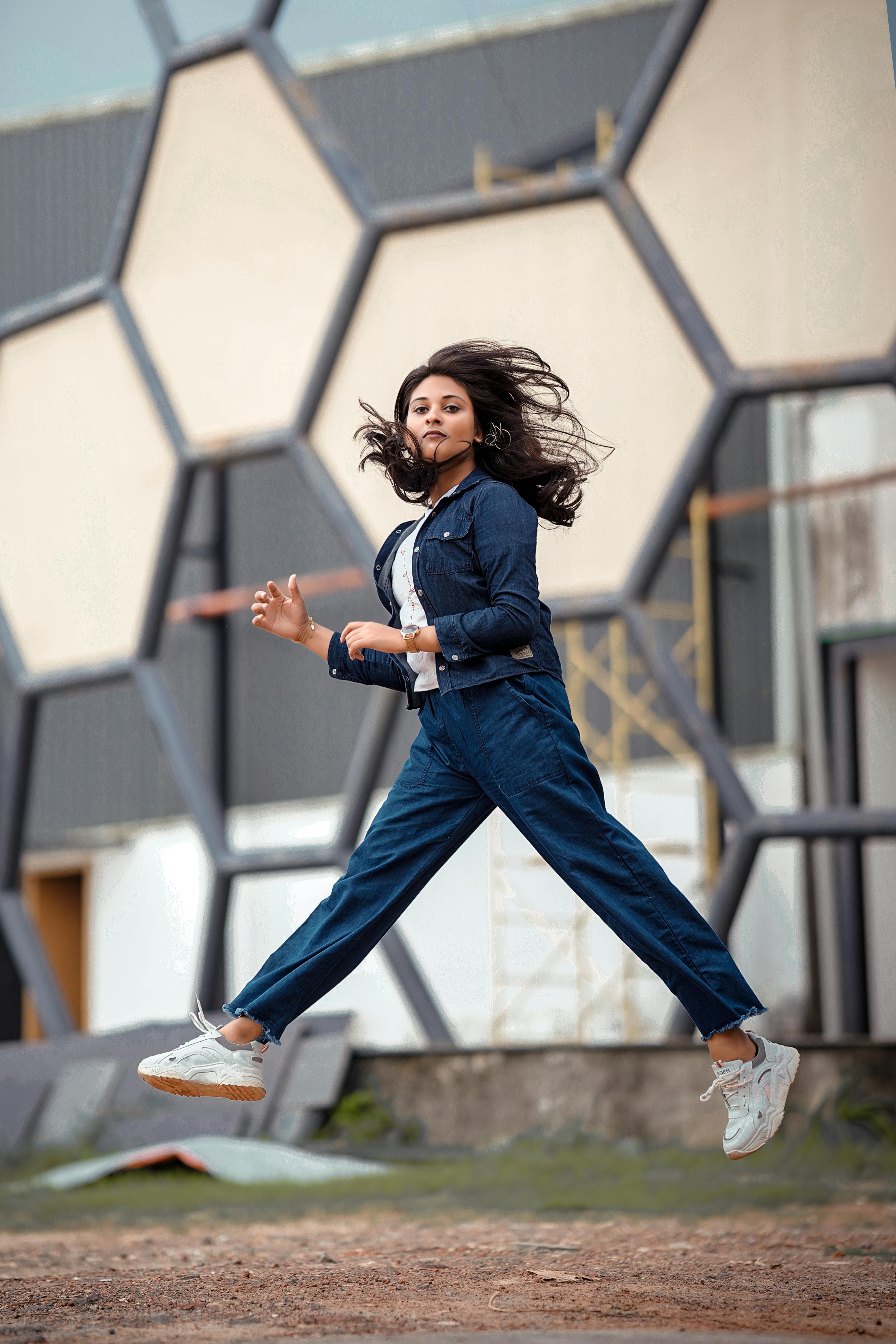 A Woman in Denim Outfit Doing Jump Shot · Free Stock Photo