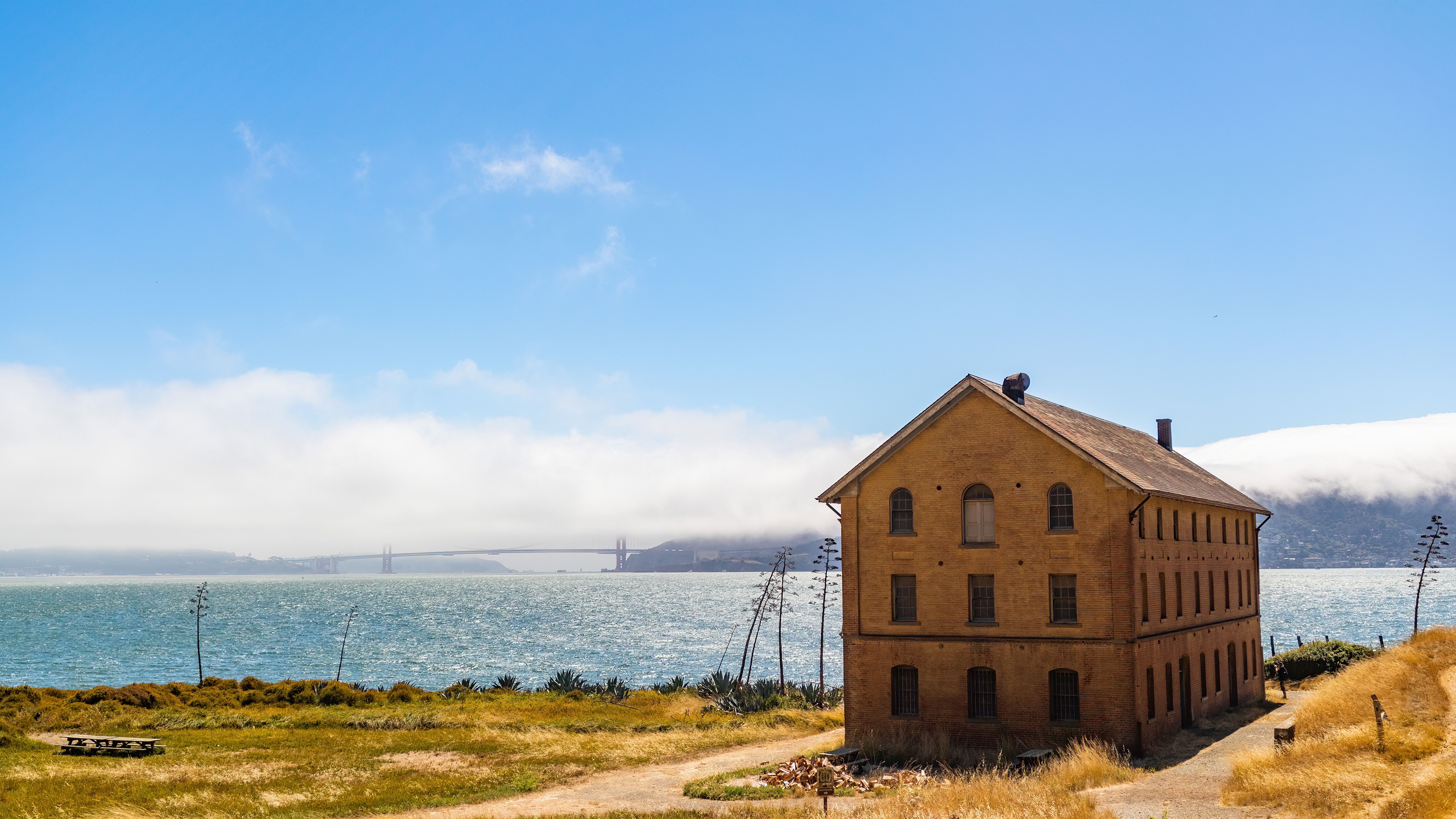 A Brown Concrete Building Near Body of Water · Free Stock Photo