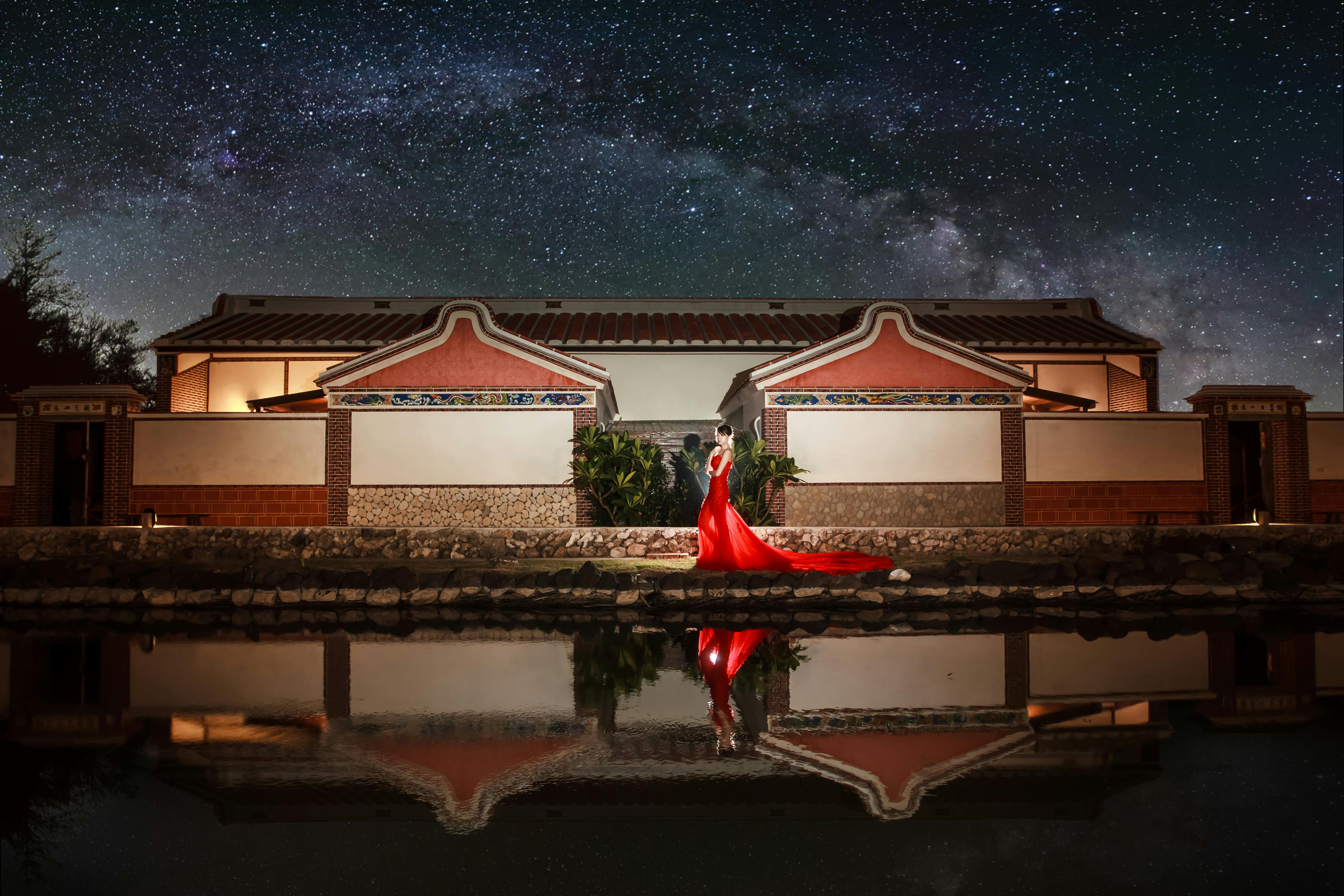 A Woman Wearing a Red Dress under a Starry Night Sky · Free Stock Photo