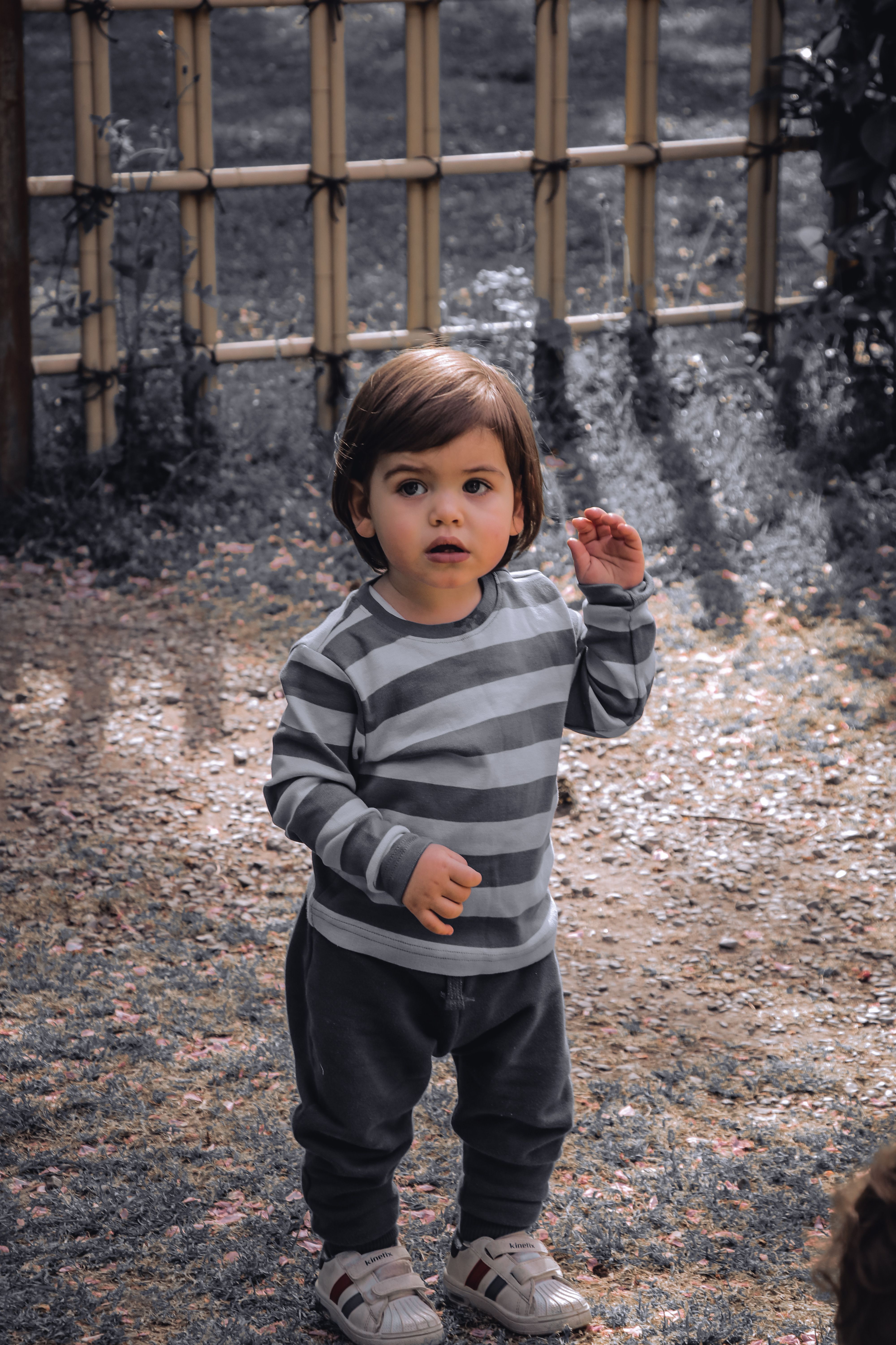 Little Boy in Monk Robes Leaning Against Pillar · Free Stock Photo