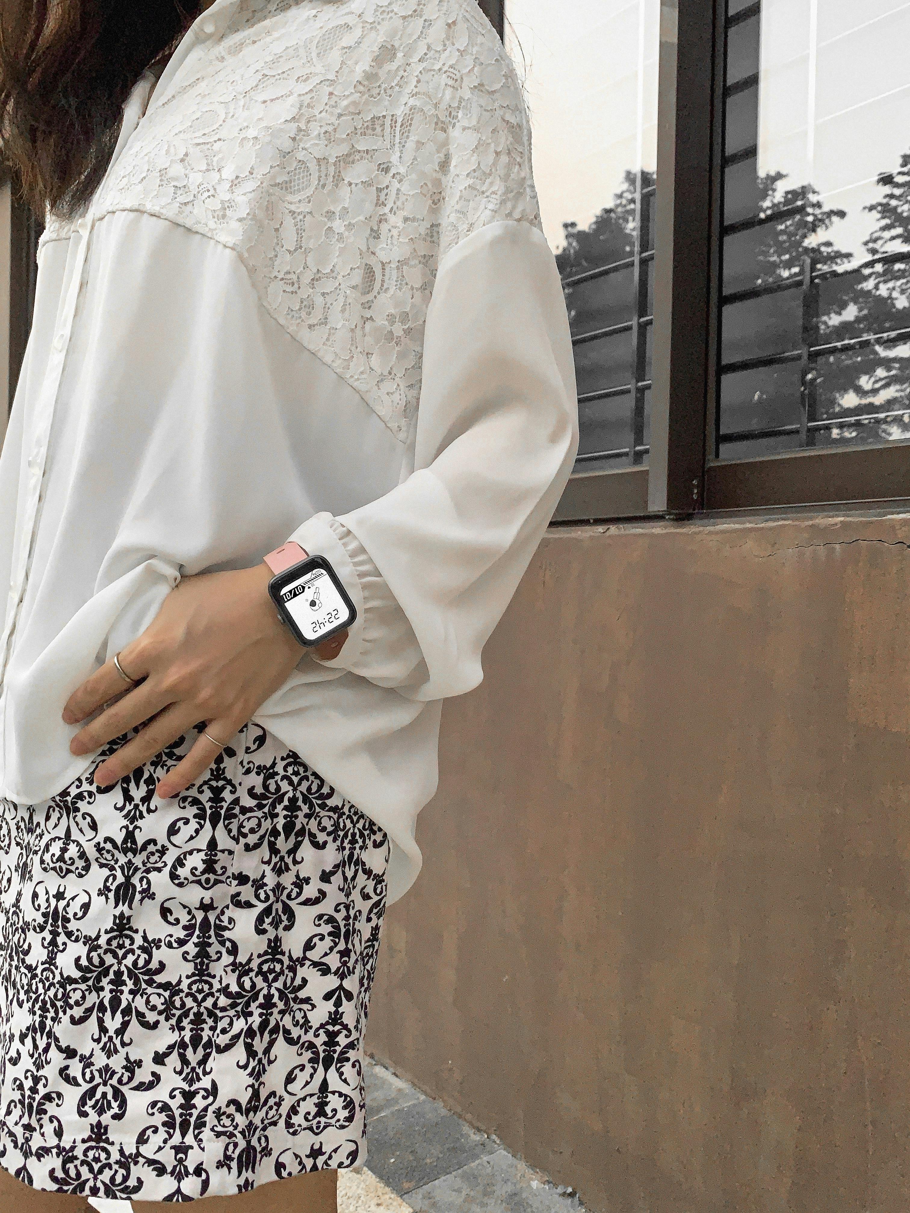Woman in White Long Sleeve Shirt Wearing a Smartwatch · Free Stock Photo