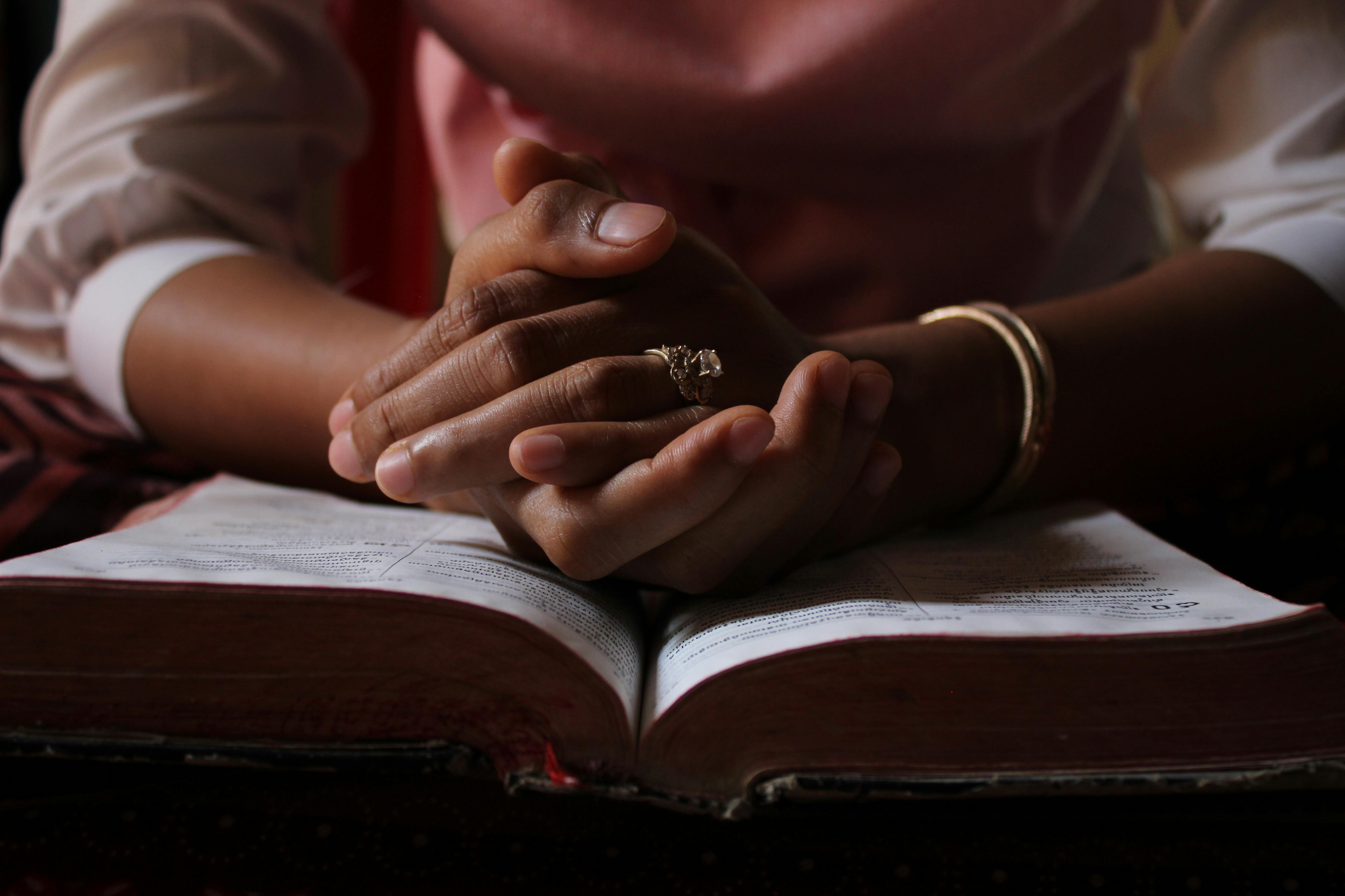 Praying on the Bible · Free Stock Photo