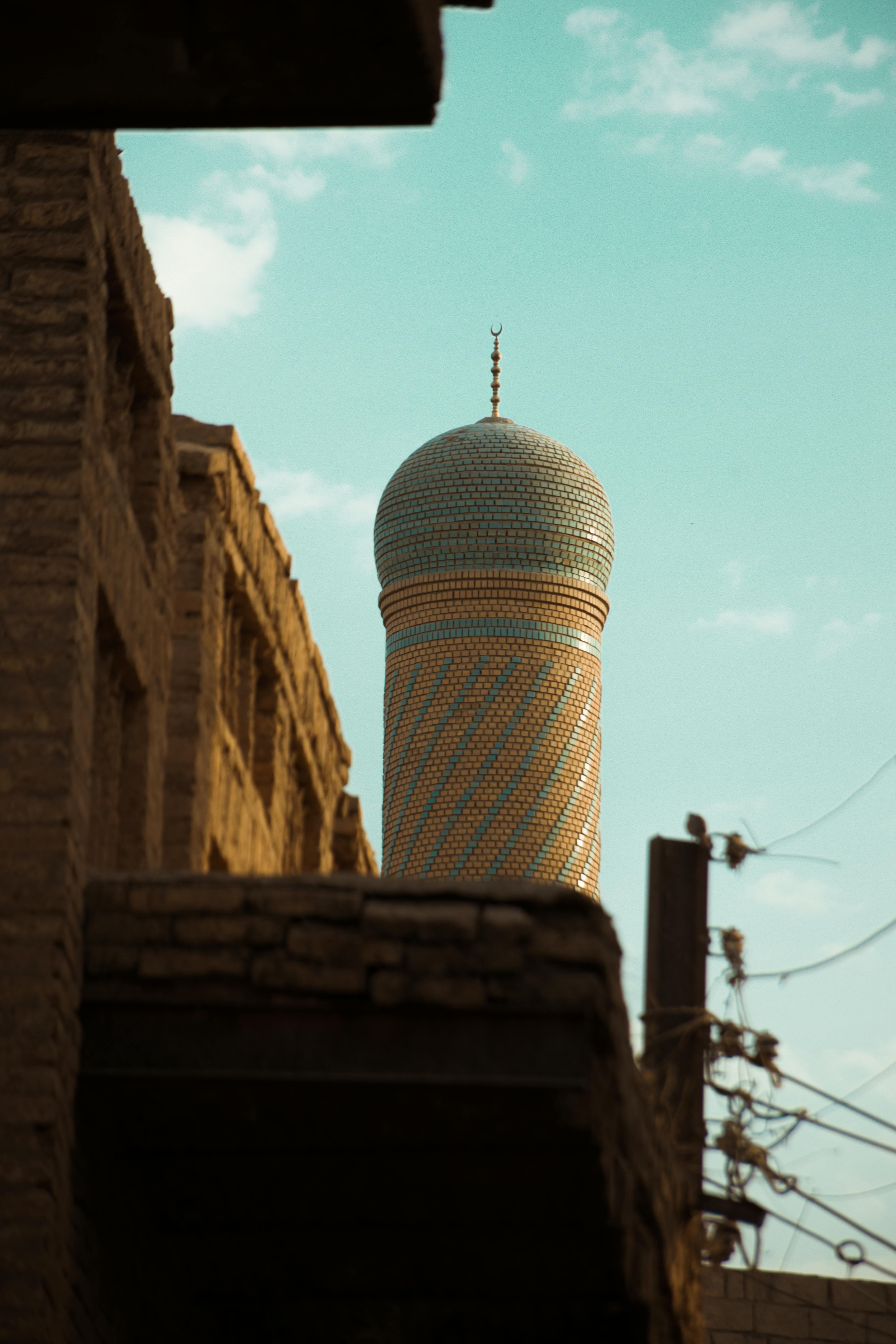 Ornate Tower Between Buildings · Free Stock Photo