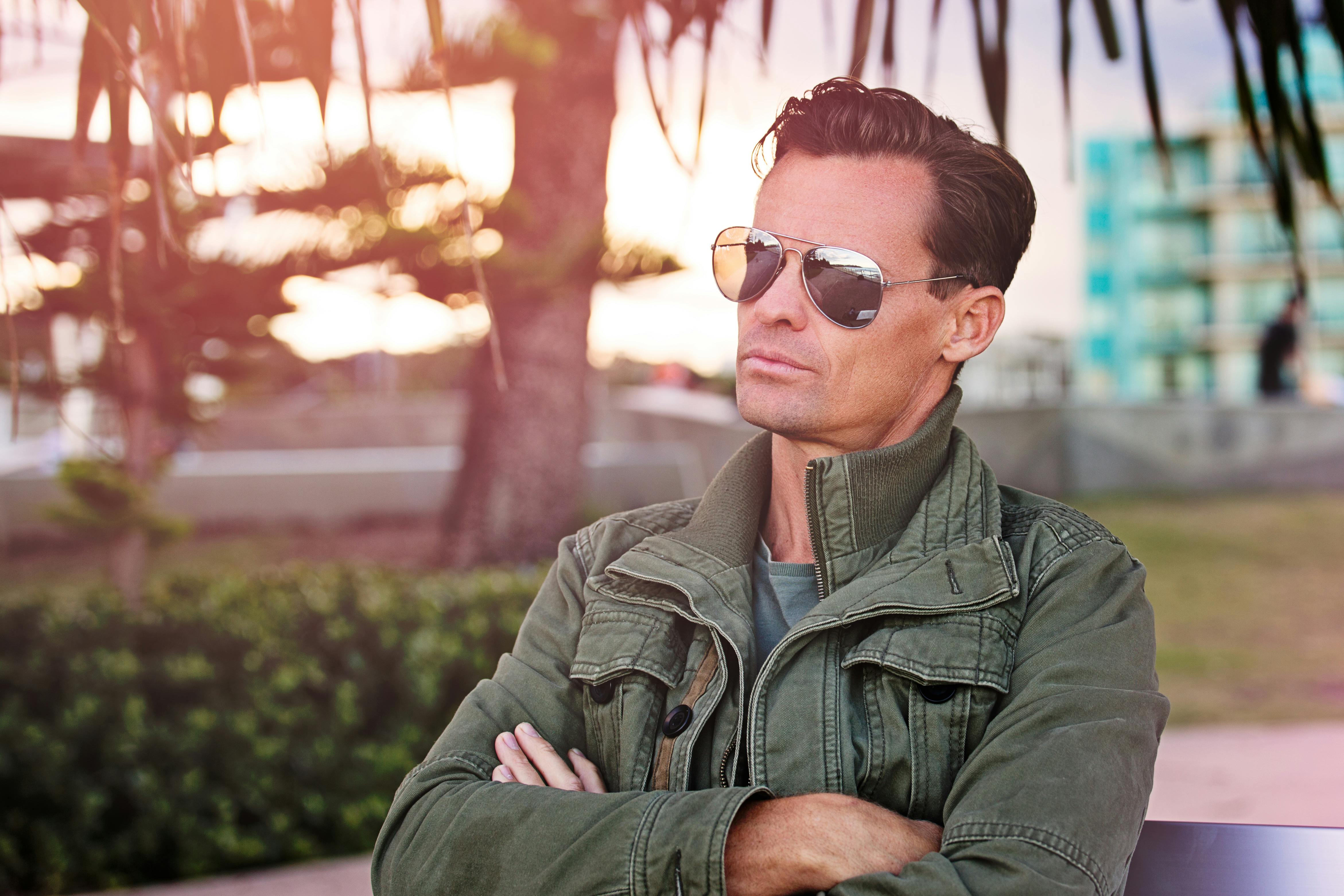 Man Wearing Sunglasses Sitting on Bench · Free Stock Photo