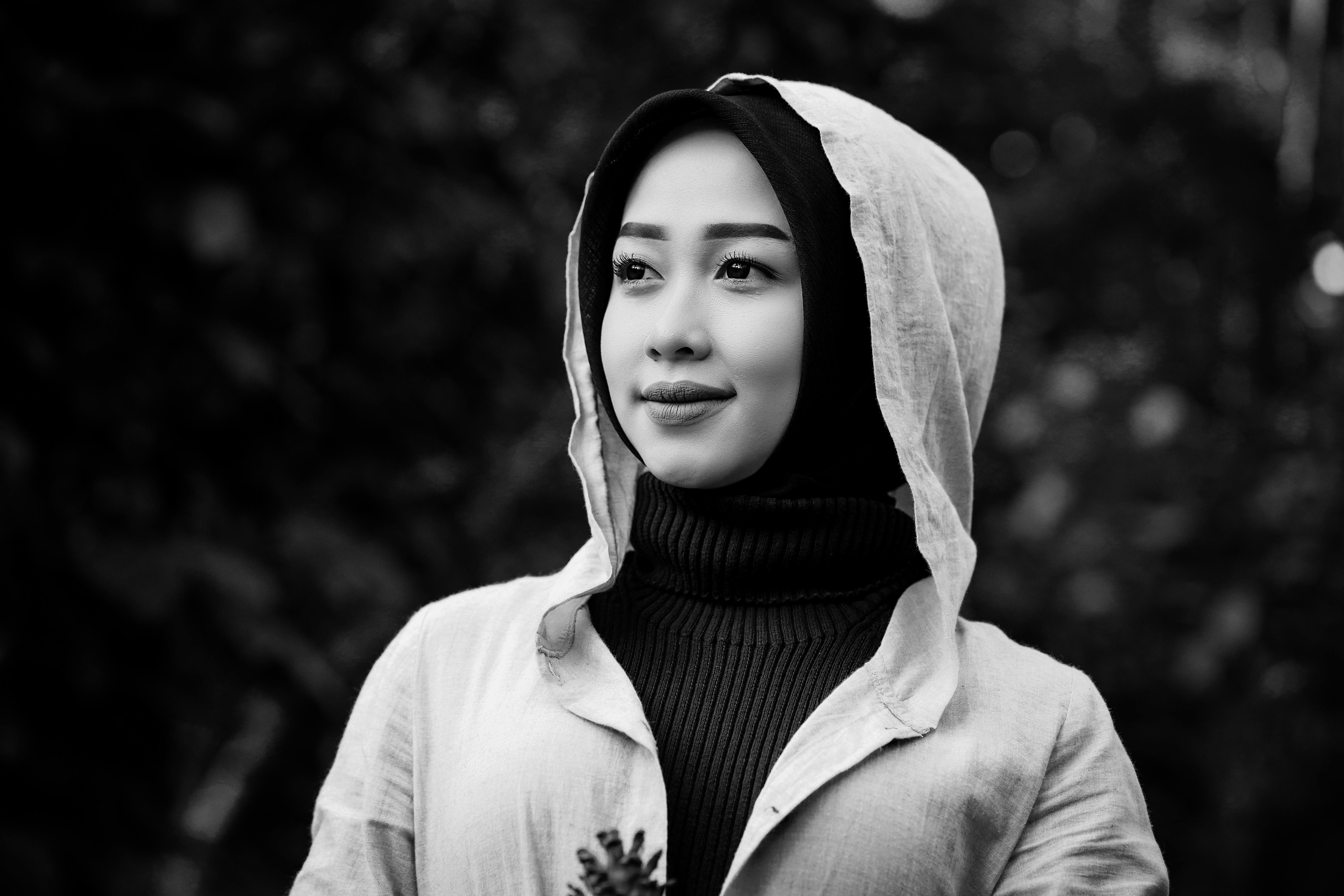 Grayscale Photo of Woman Wearing Hoodie Smiling · Free Stock Photo