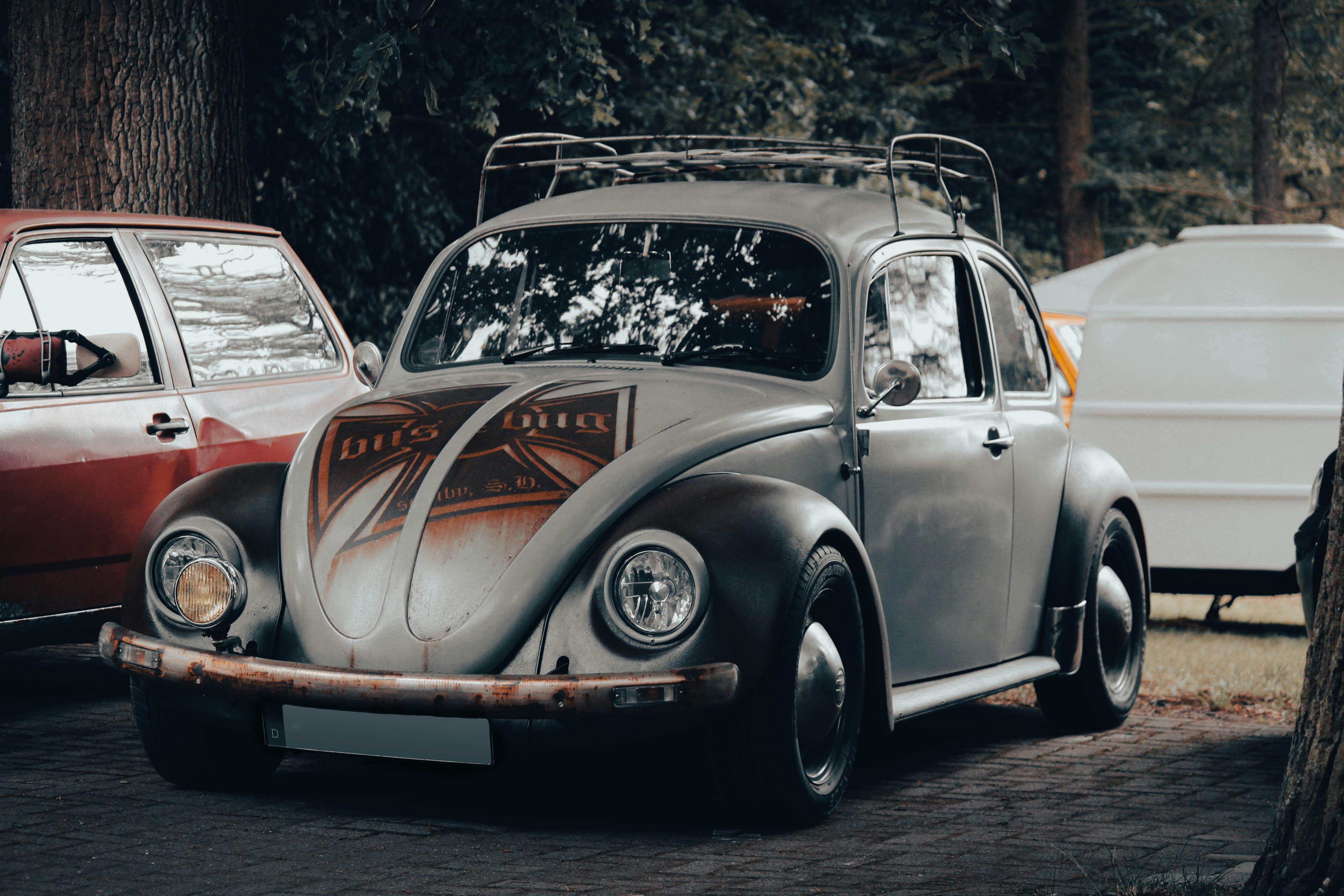 A Gray Volkswagen Parked Beside Red Car · Free Stock Photo