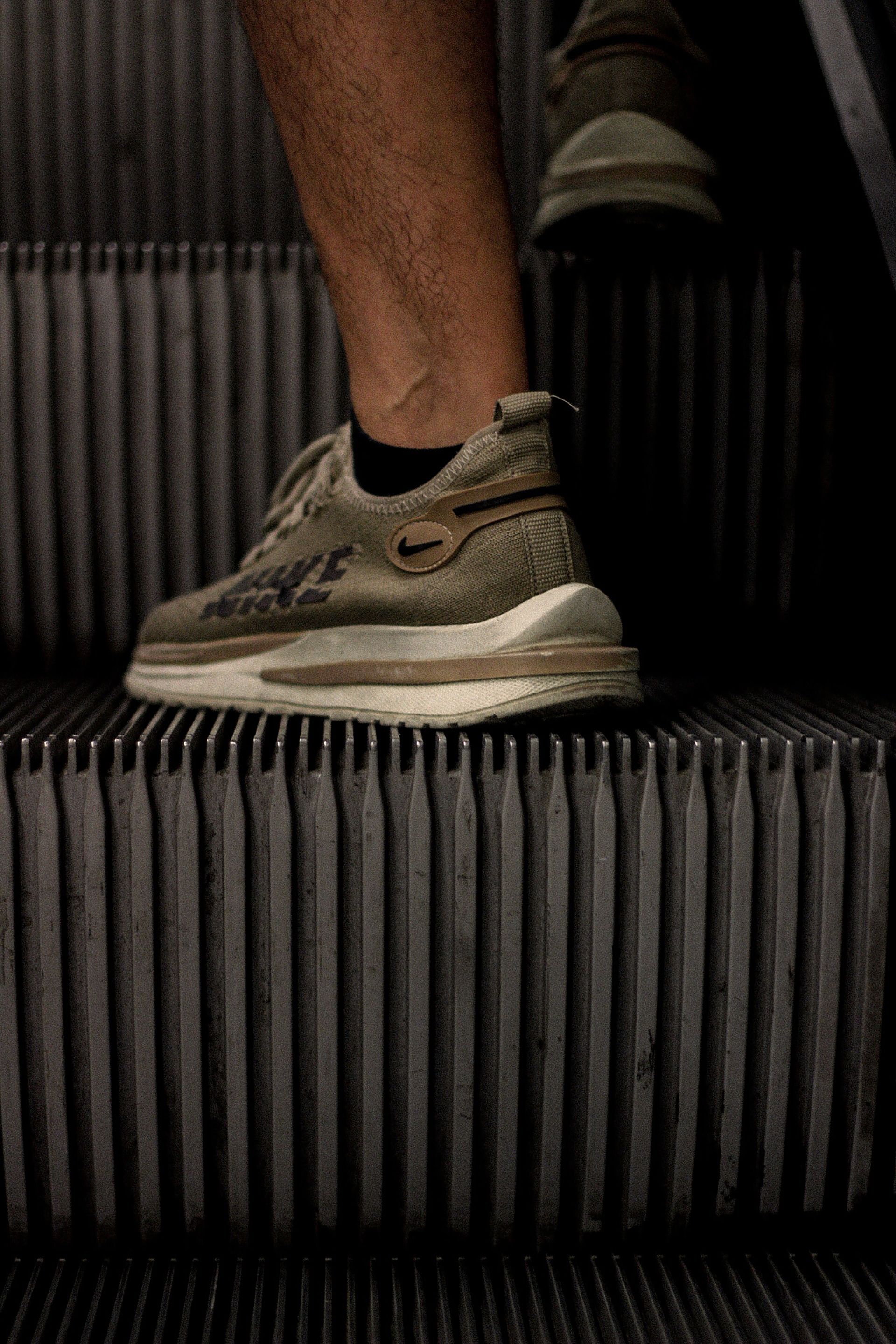 Close-Up Shot of Grey Rubber Shoes on Wooden Surface · Free Stock Photo