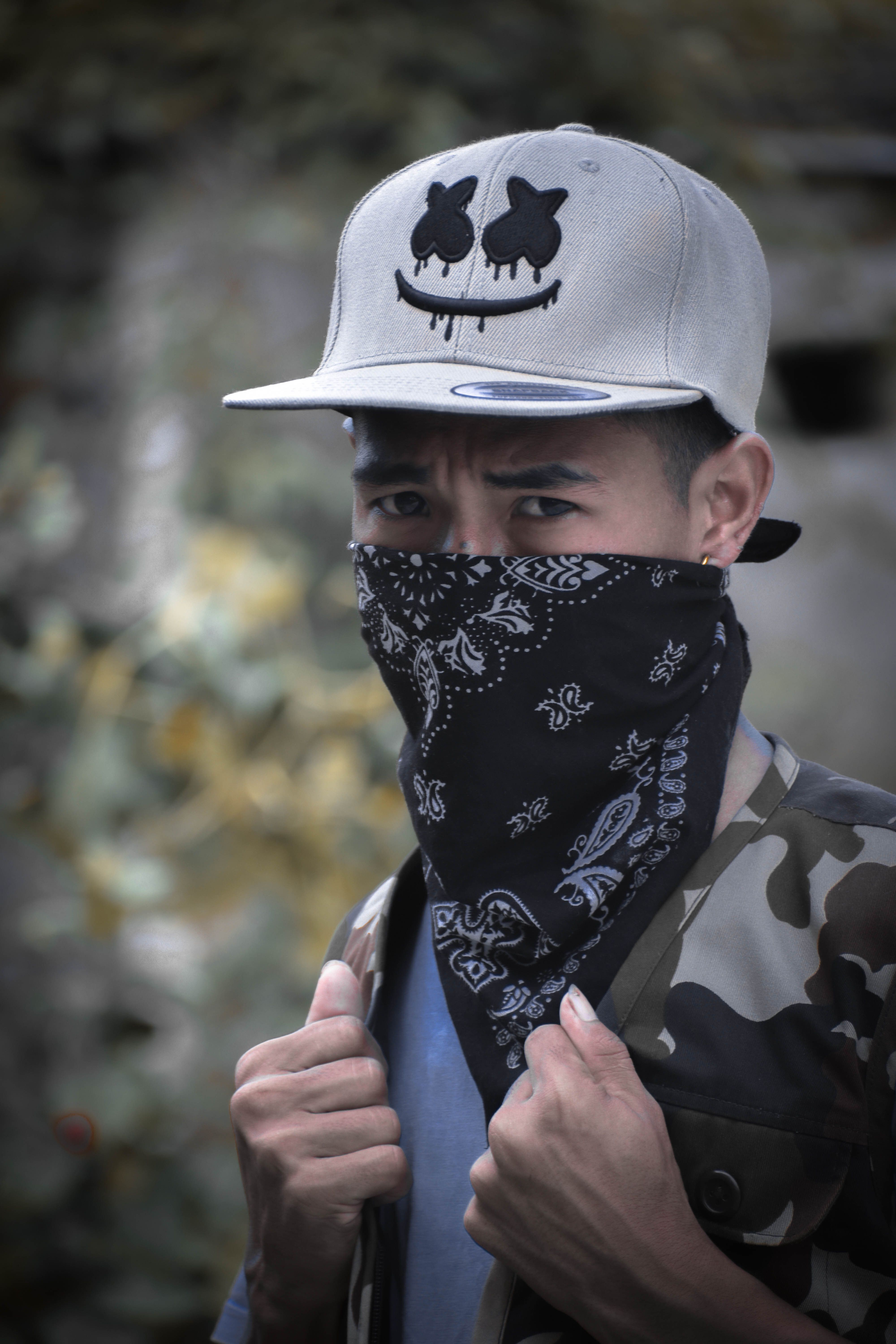 A Young Man with a Cap and Kerchief over His Face · Free Stock Photo